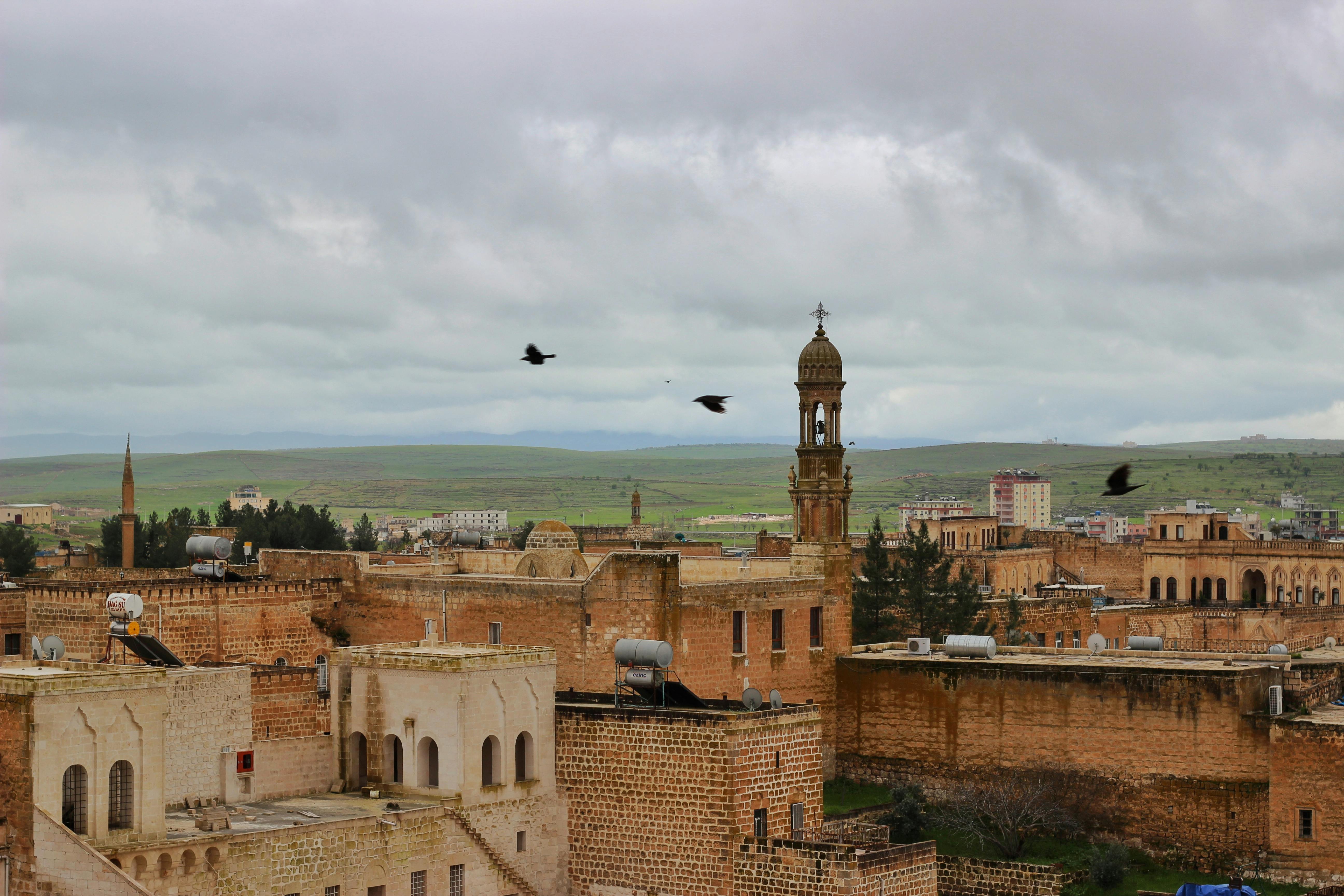 Church Tower behind Buildings in Midyat in Turkey · Free Stock Photo