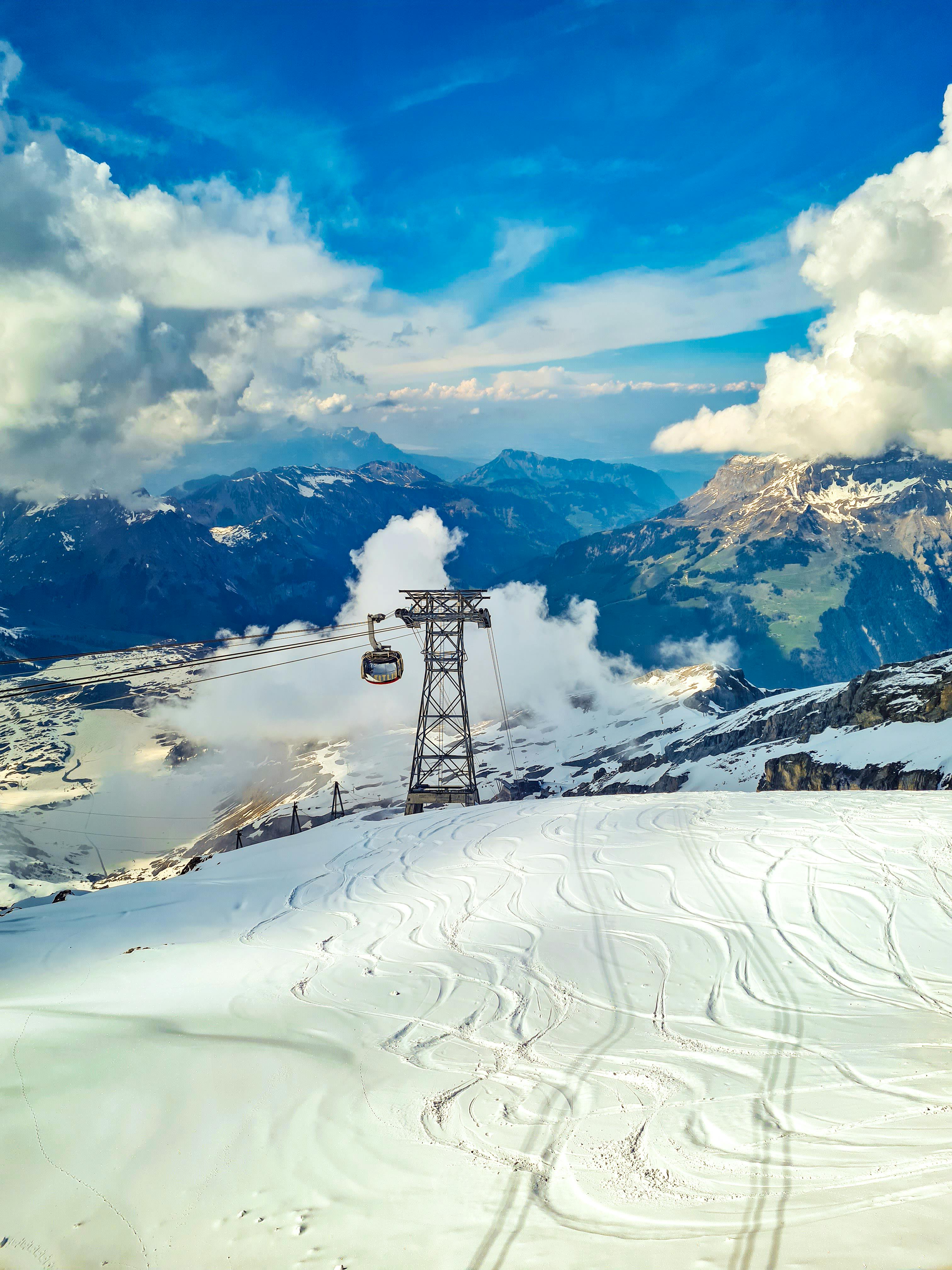 Scenic View of Snow Mountains Against Blue Sky · Free Stock Photo