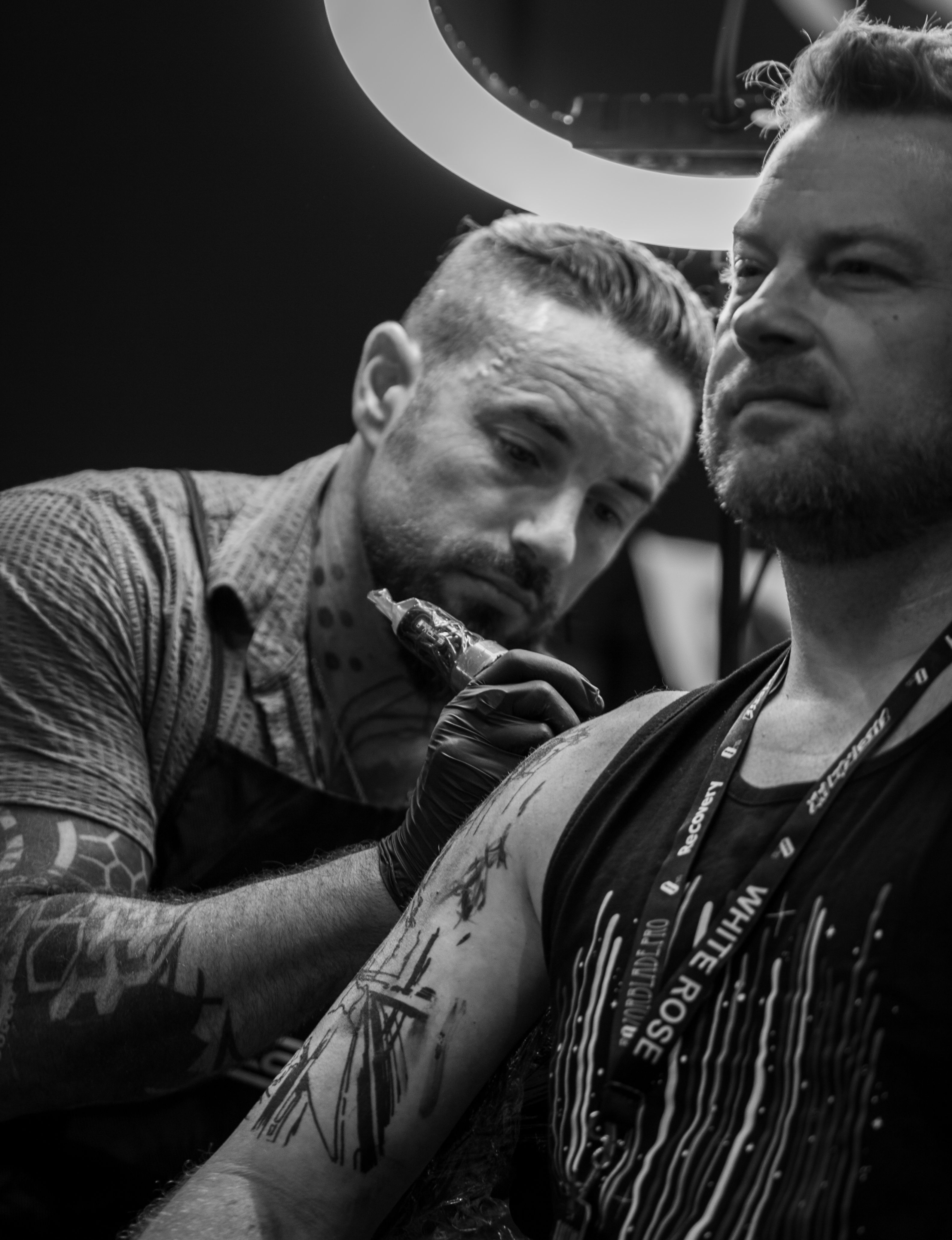 Man Holding Tattoo Machine And Tattooing Person Arm · Free Stock Photo