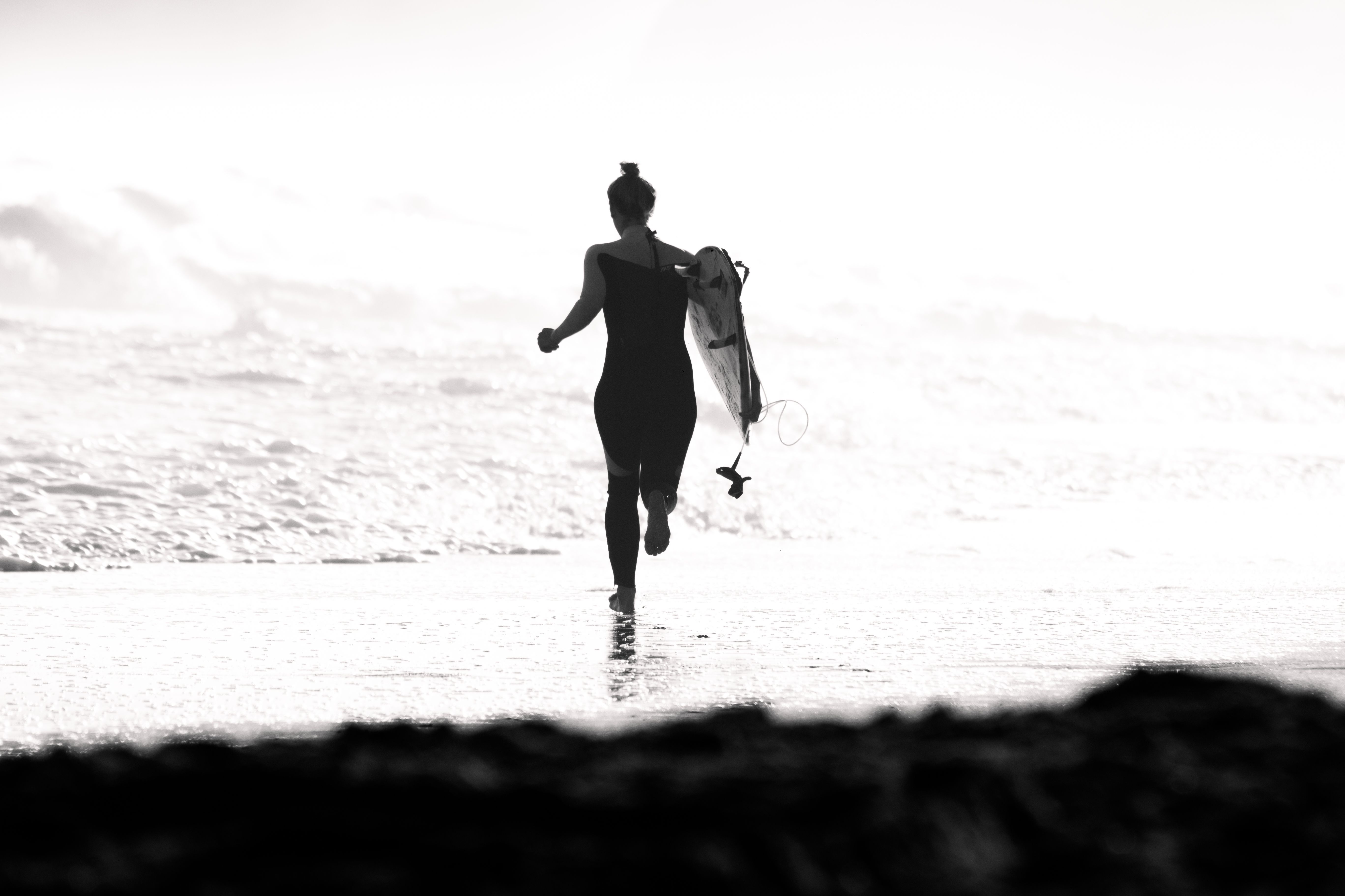 Woman Running into Sea with Surfboard · Free Stock Photo