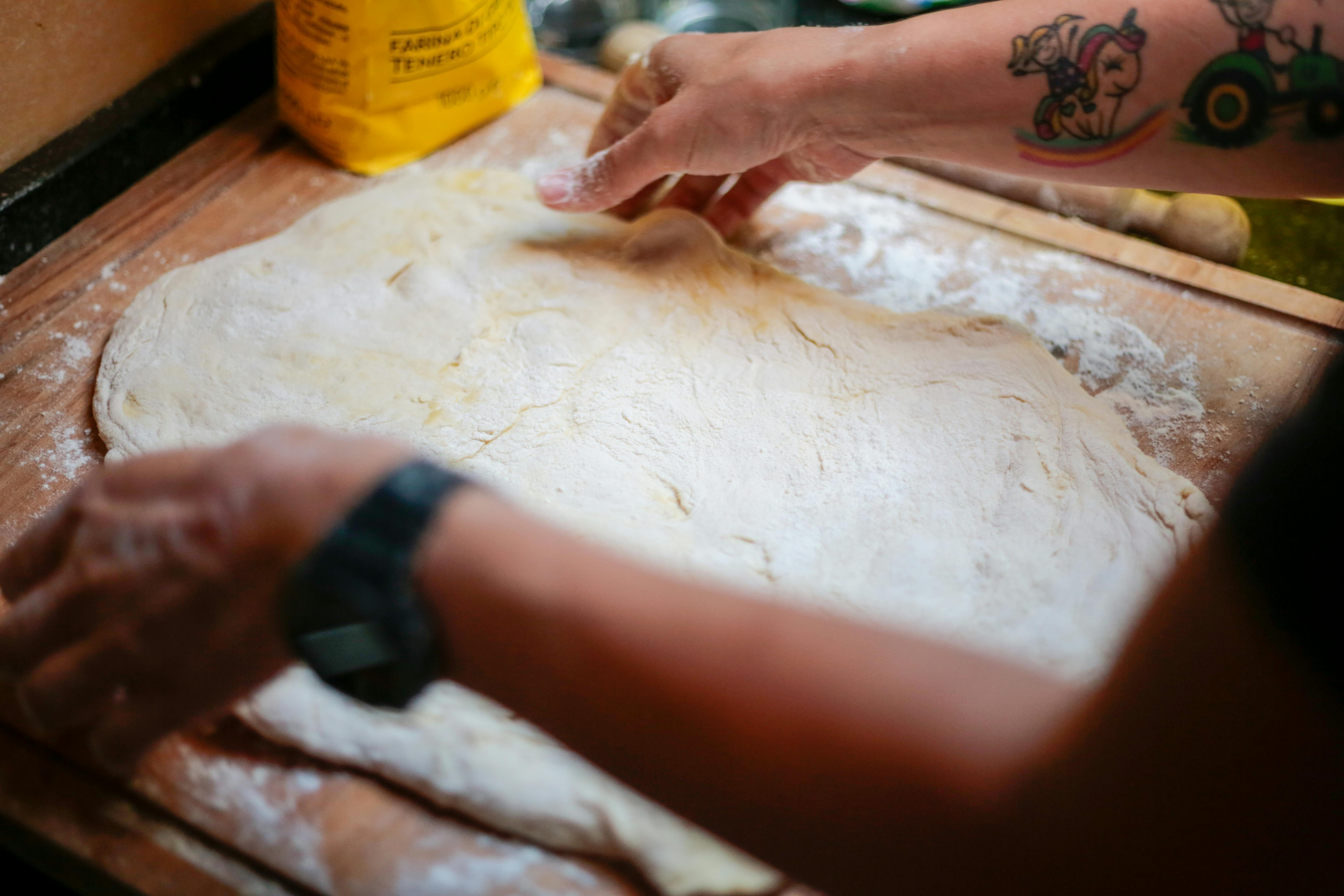 A Person Shaping a Lump of Dough · Free Stock Photo