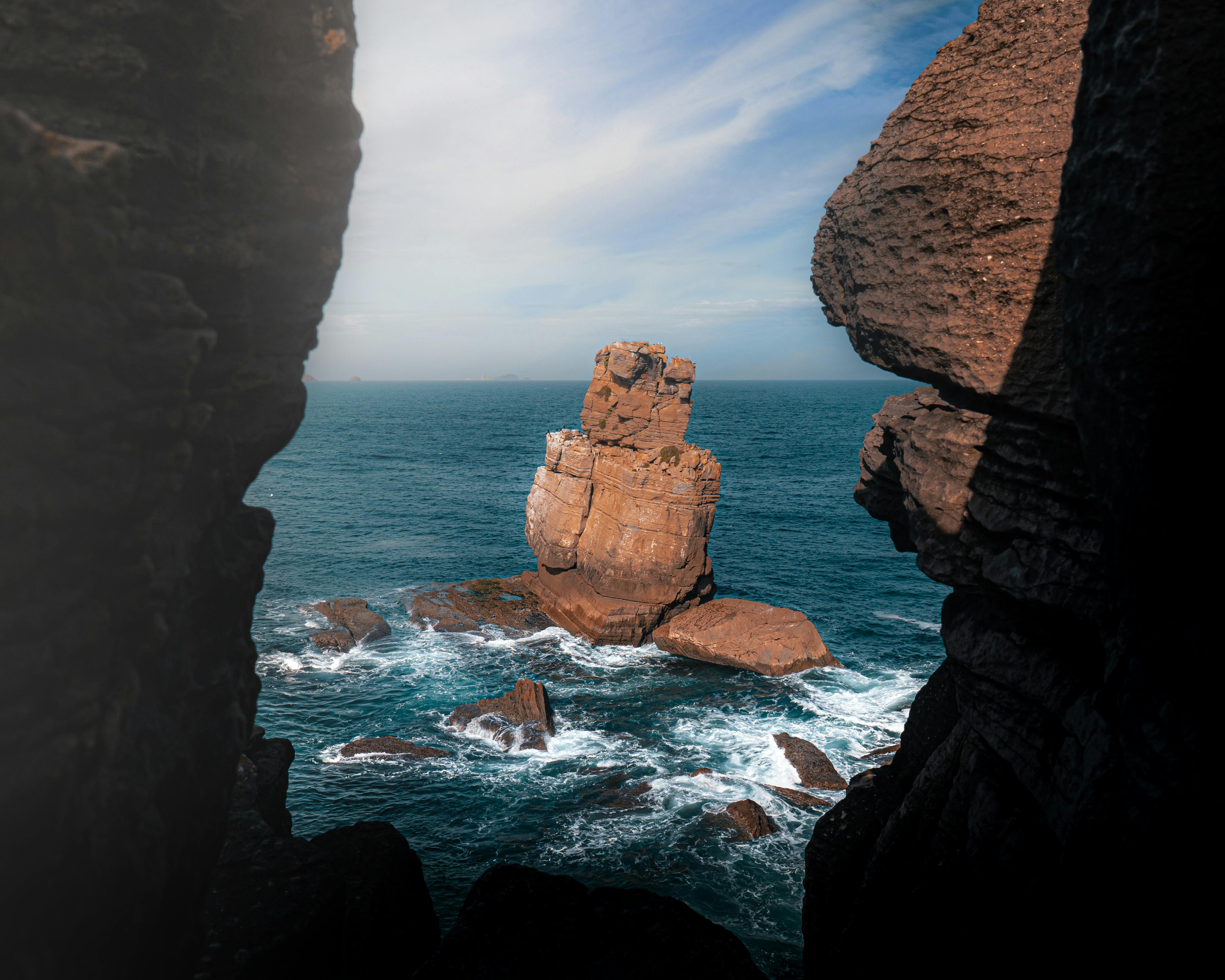 Photo of a Stone Cliff over Water · Free Stock Photo
