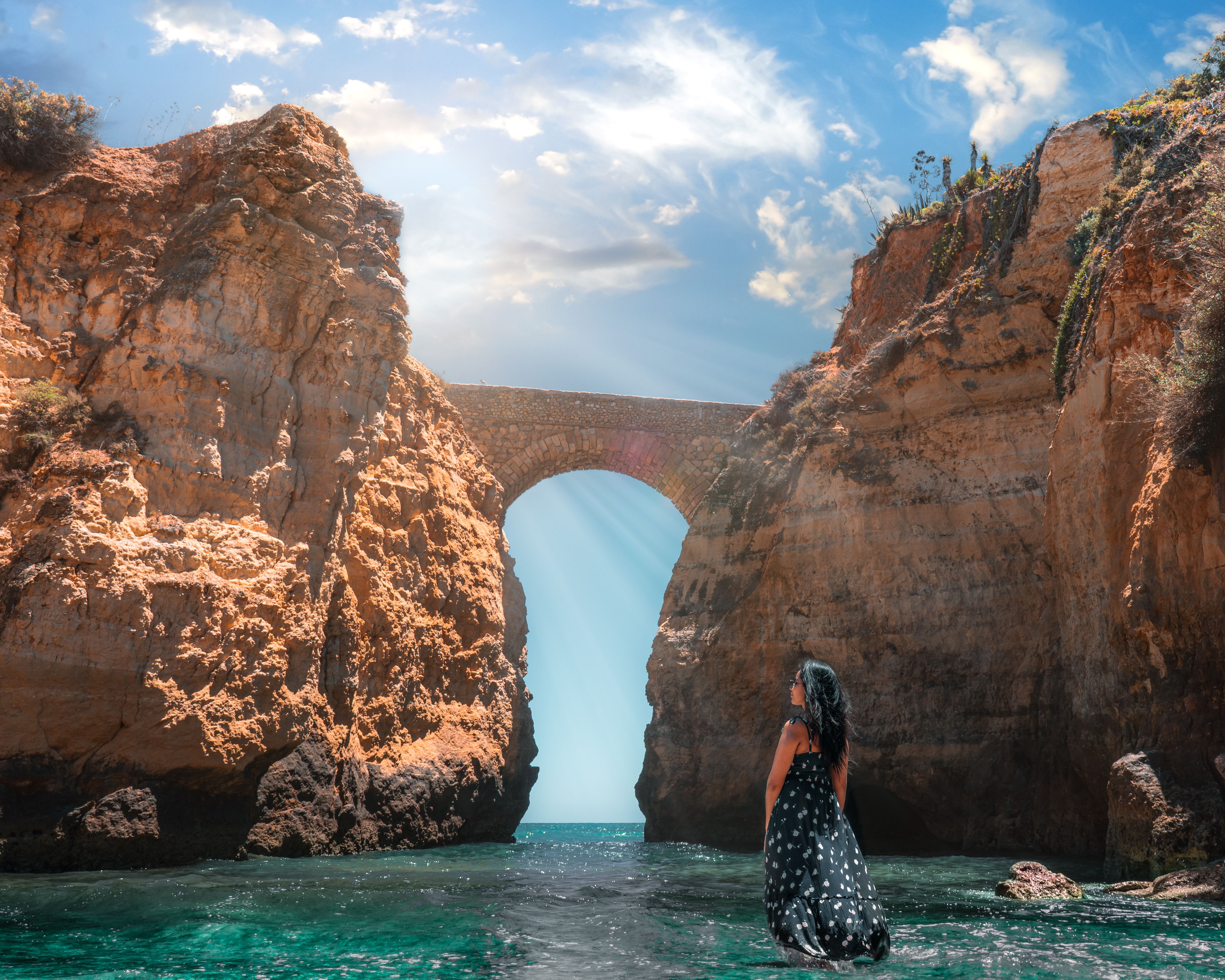 Woman Standing in the Sea by Cliffs · Free Stock Photo