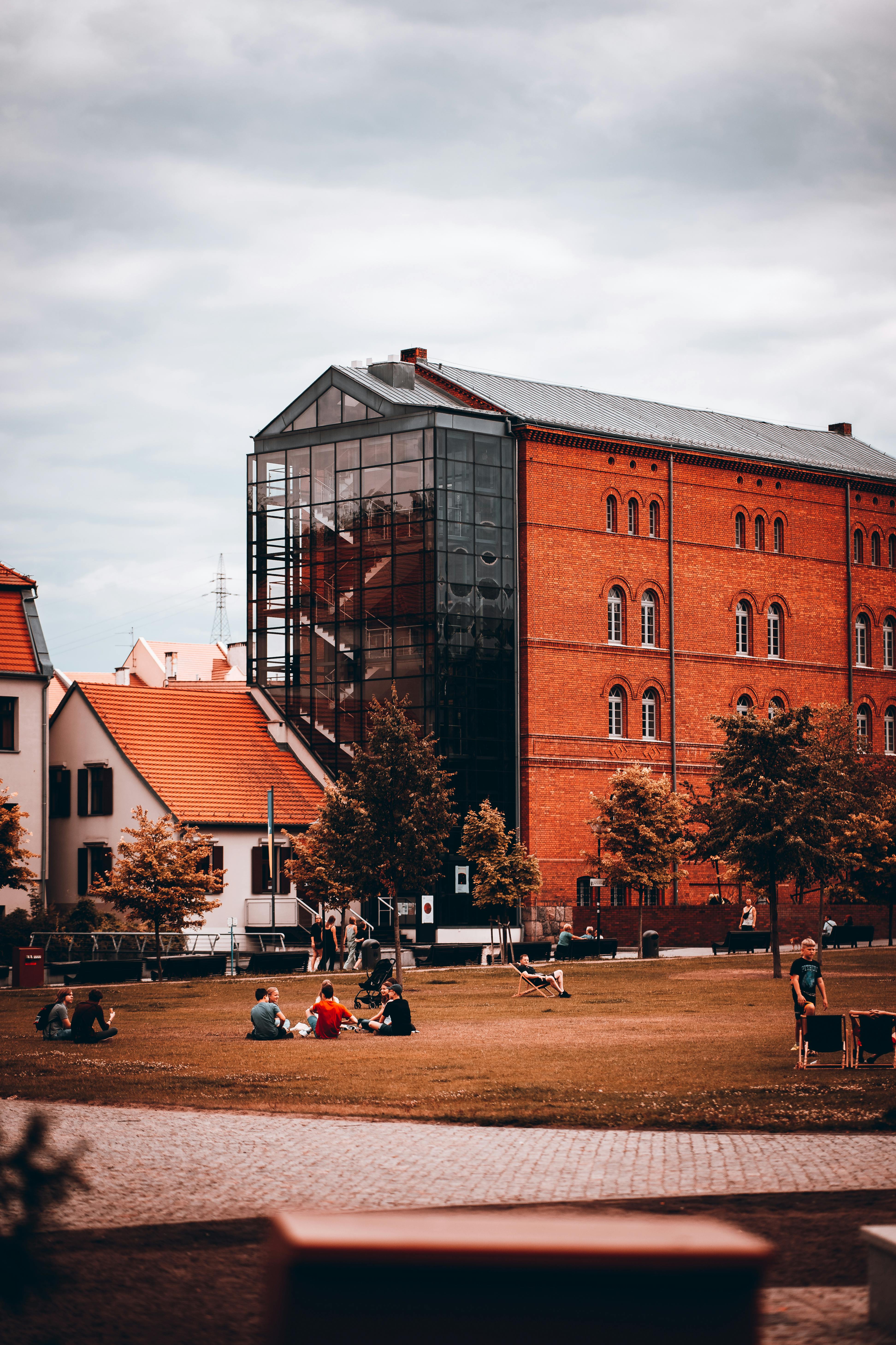 Park Near a Brick Building · Free Stock Photo