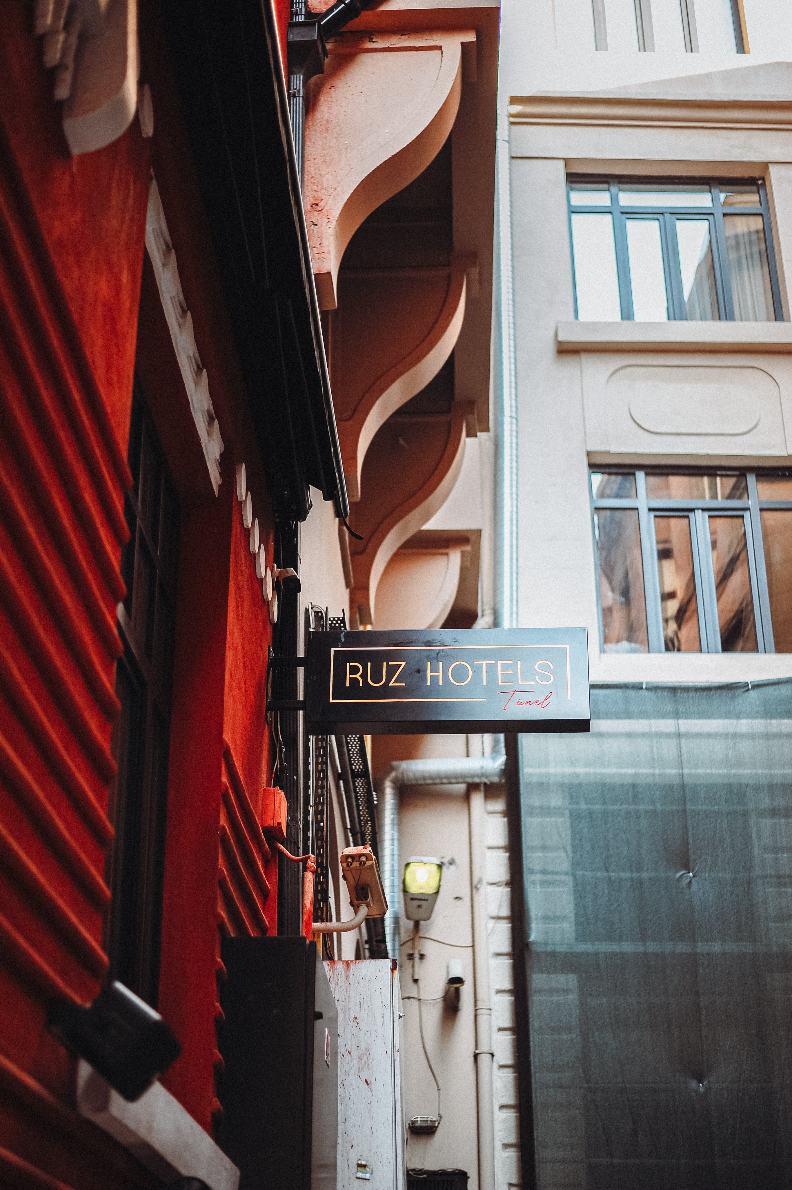 Hotel Sign Hanging on Building Wall · Free Stock Photo