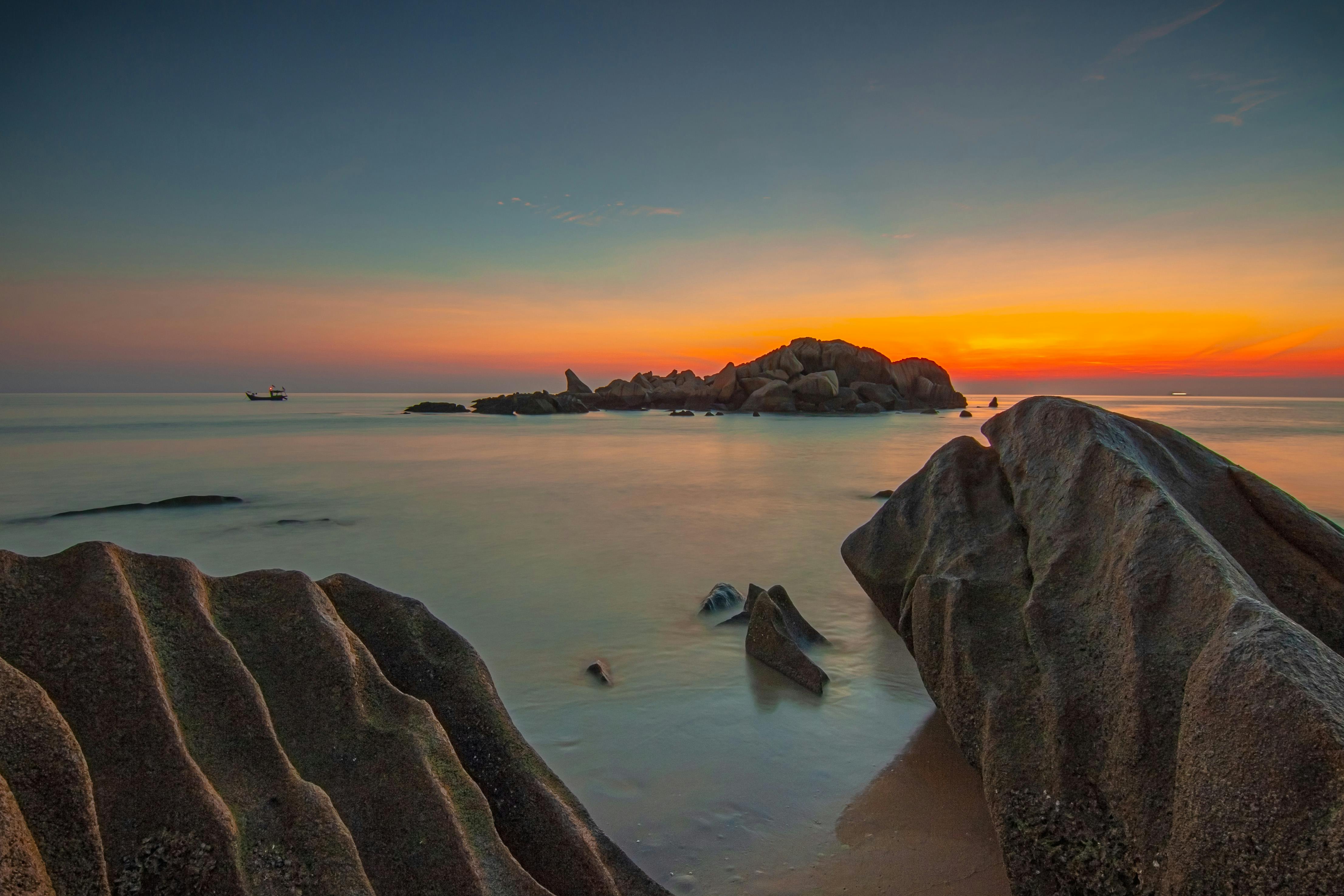 Rock Formations on Ocean During Sunset · Free Stock Photo