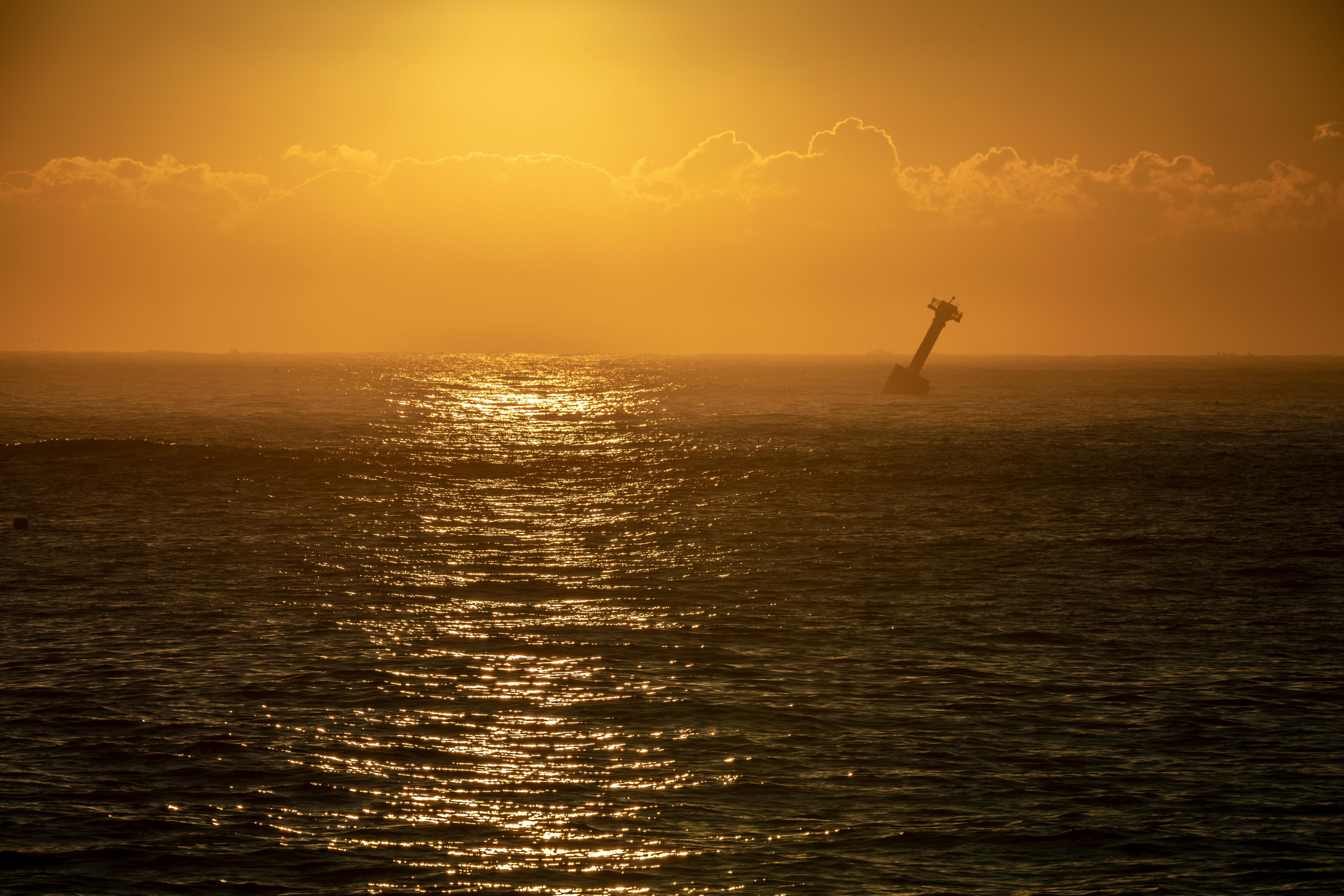 Silhouette of a Sunken Ship at Sea · Free Stock Photo