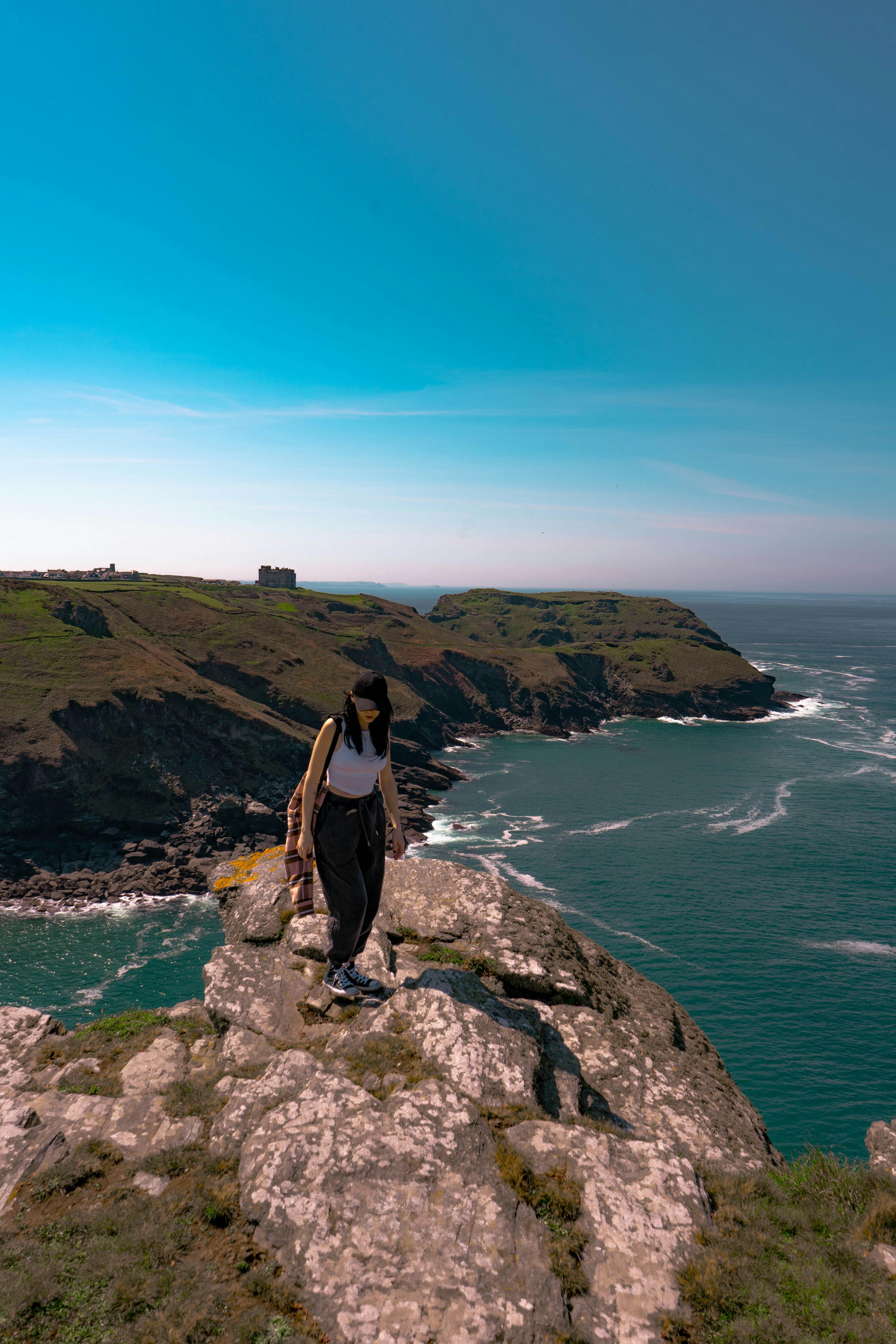 Woman in a Backless Dress Standing near Rock · Free Stock Photo