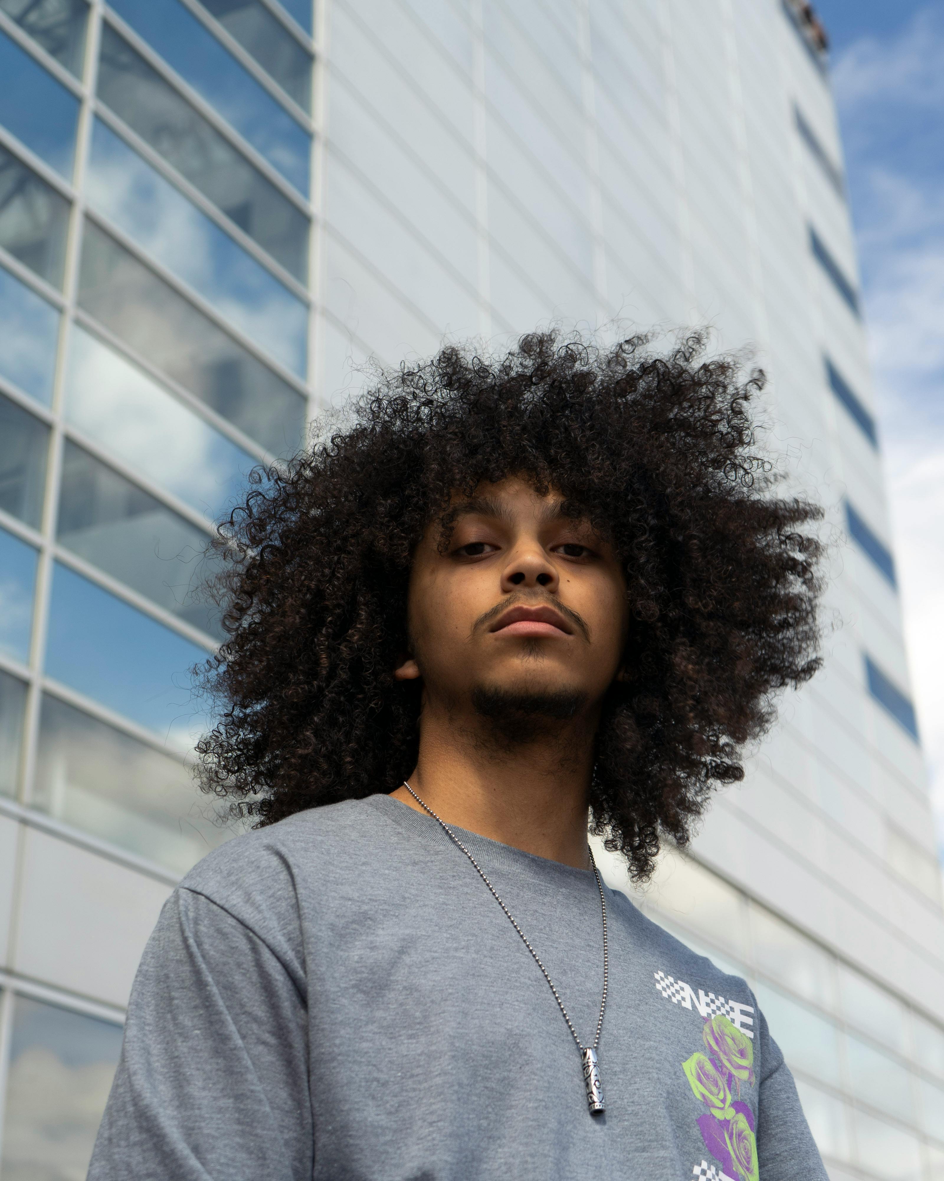 Man Looking Down From a Concrete Balcony · Free Stock Photo