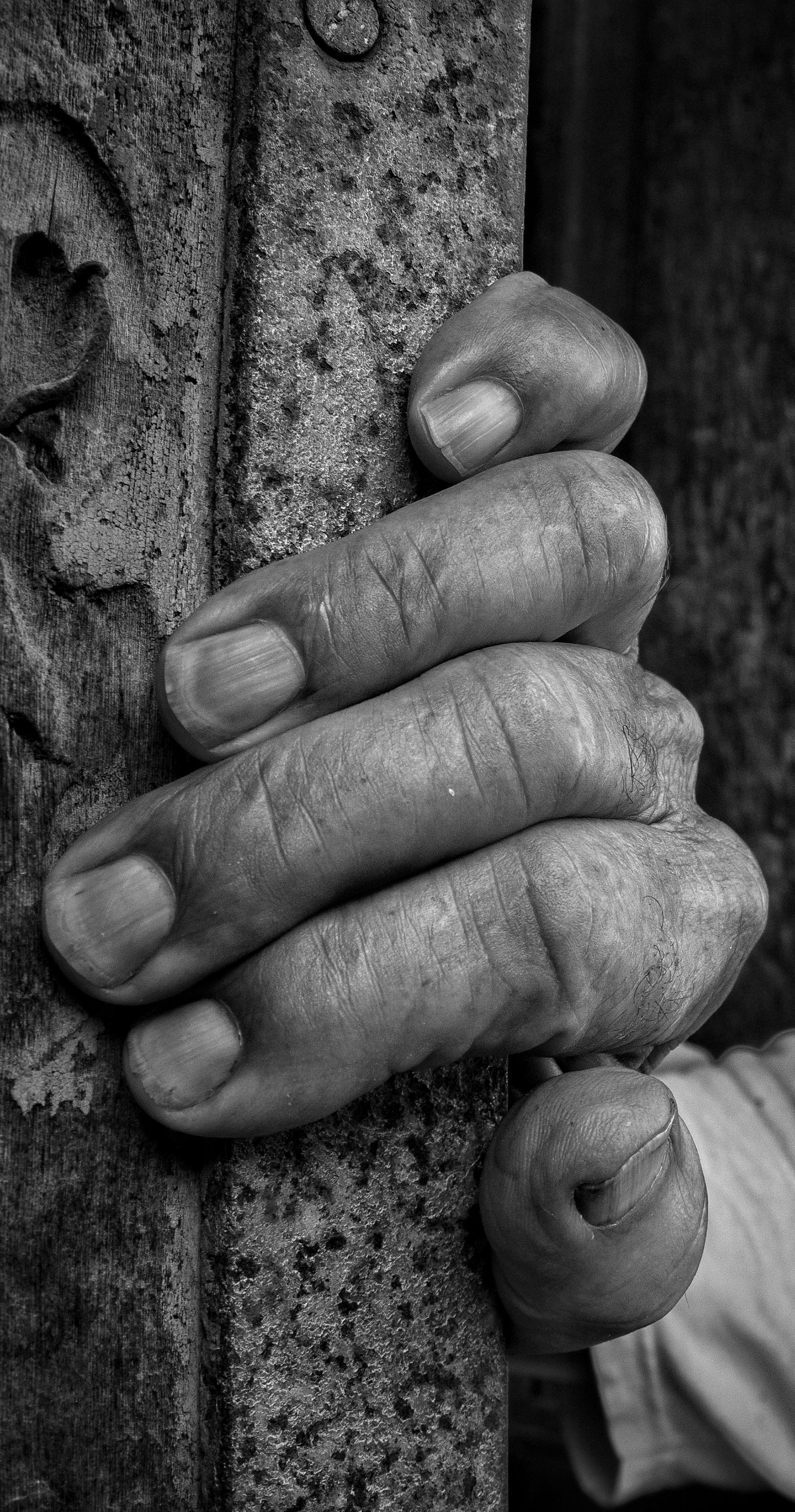 Close Up of Hand Holding Wall · Free Stock Photo