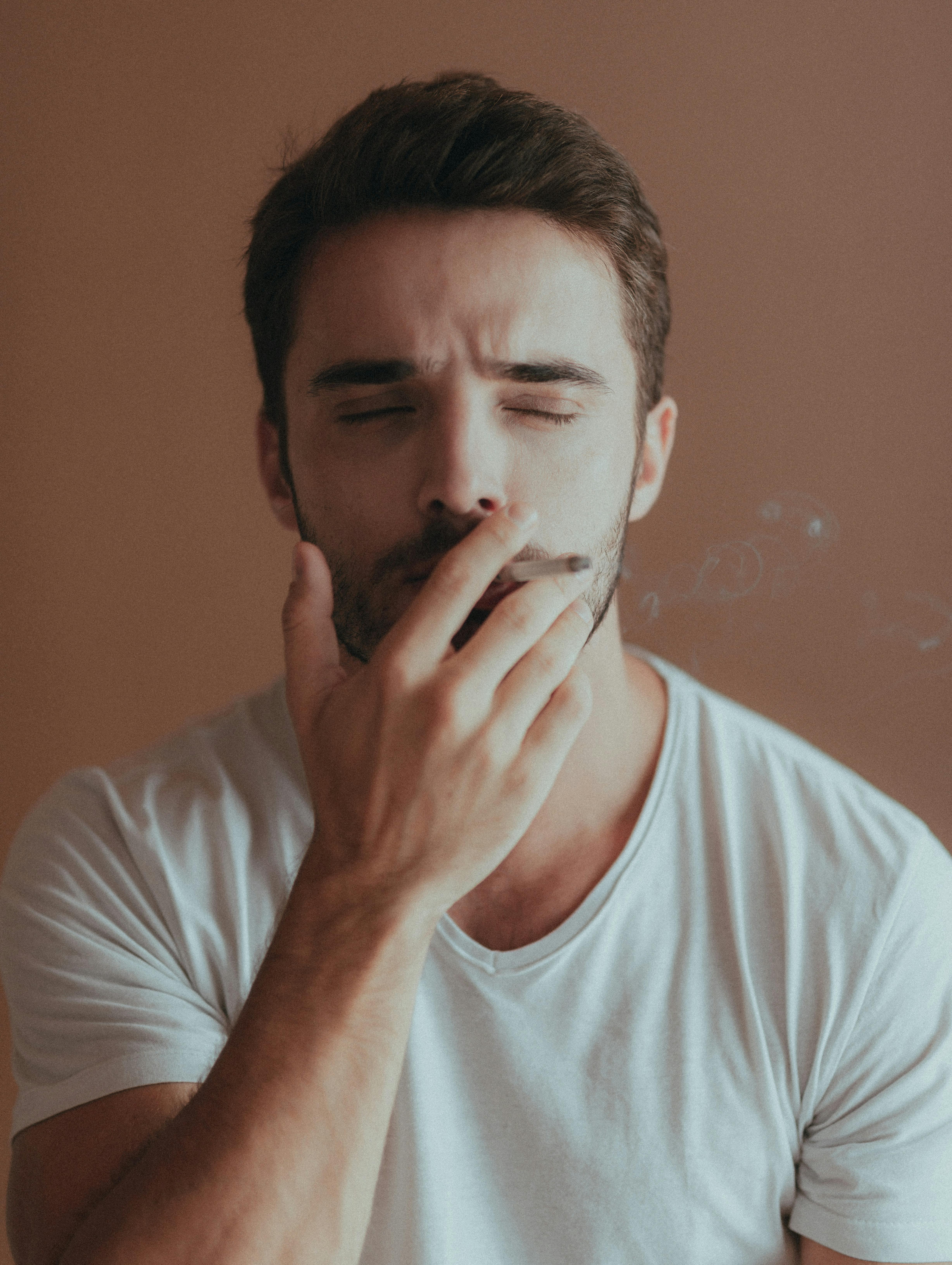 Close Up Photo of a Man Smoking Cigarette · Free Stock Photo