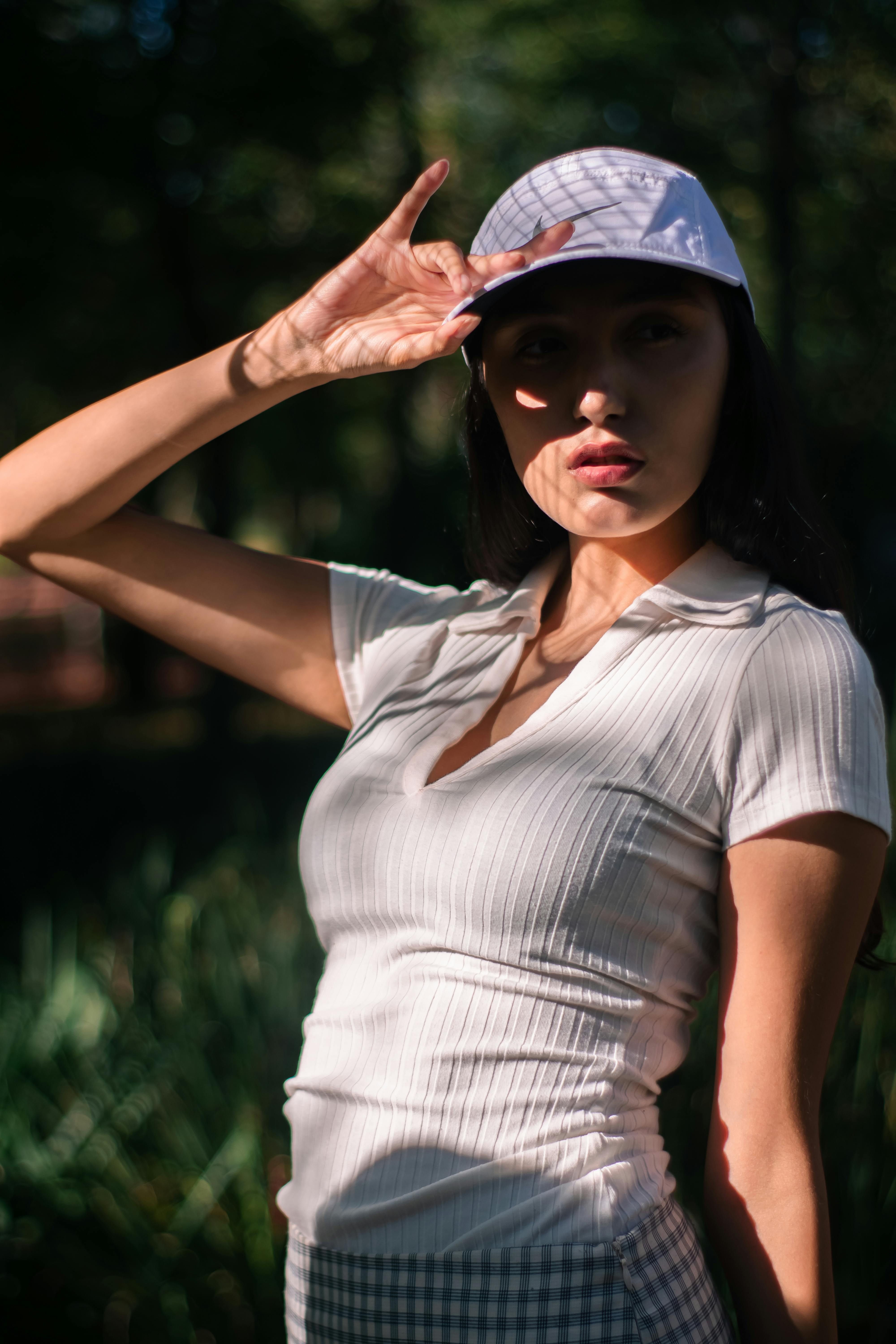 Women Wearing Caps on a Bridge · Free Stock Photo