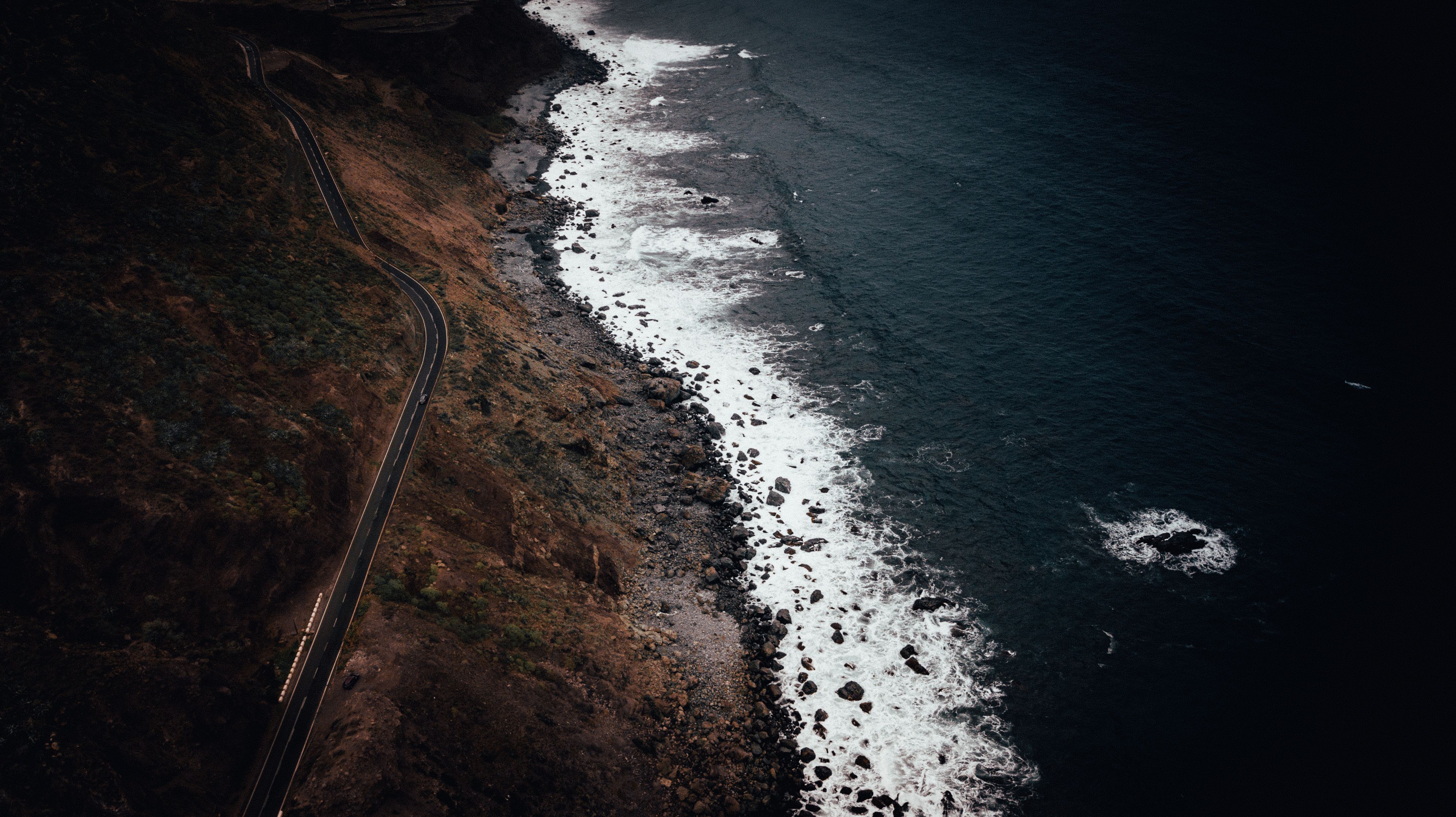 Sea Foam on the Shoreline and a Road · Free Stock Photo