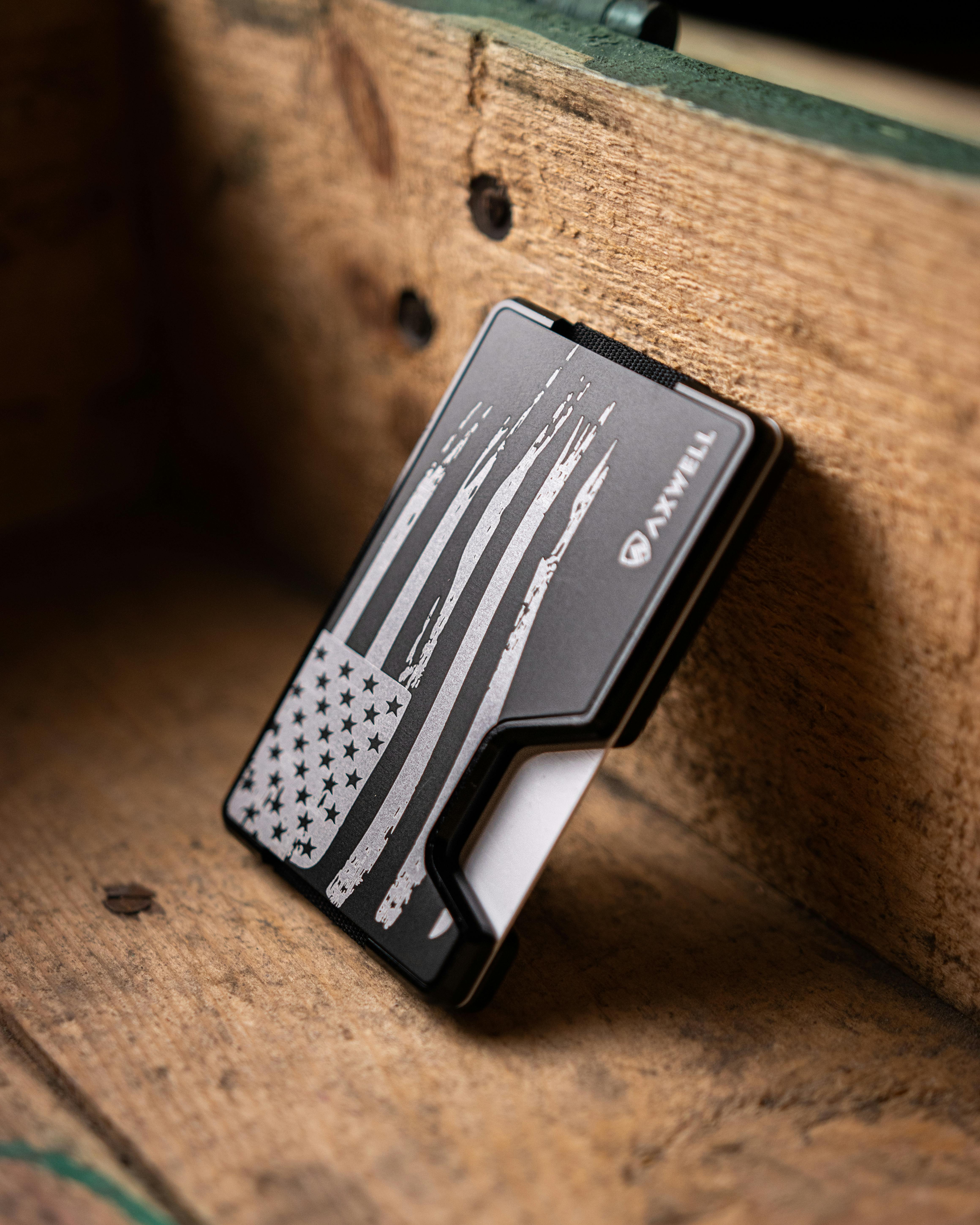 Slim Metal Wallet on Wooden Surface · Free Stock Photo