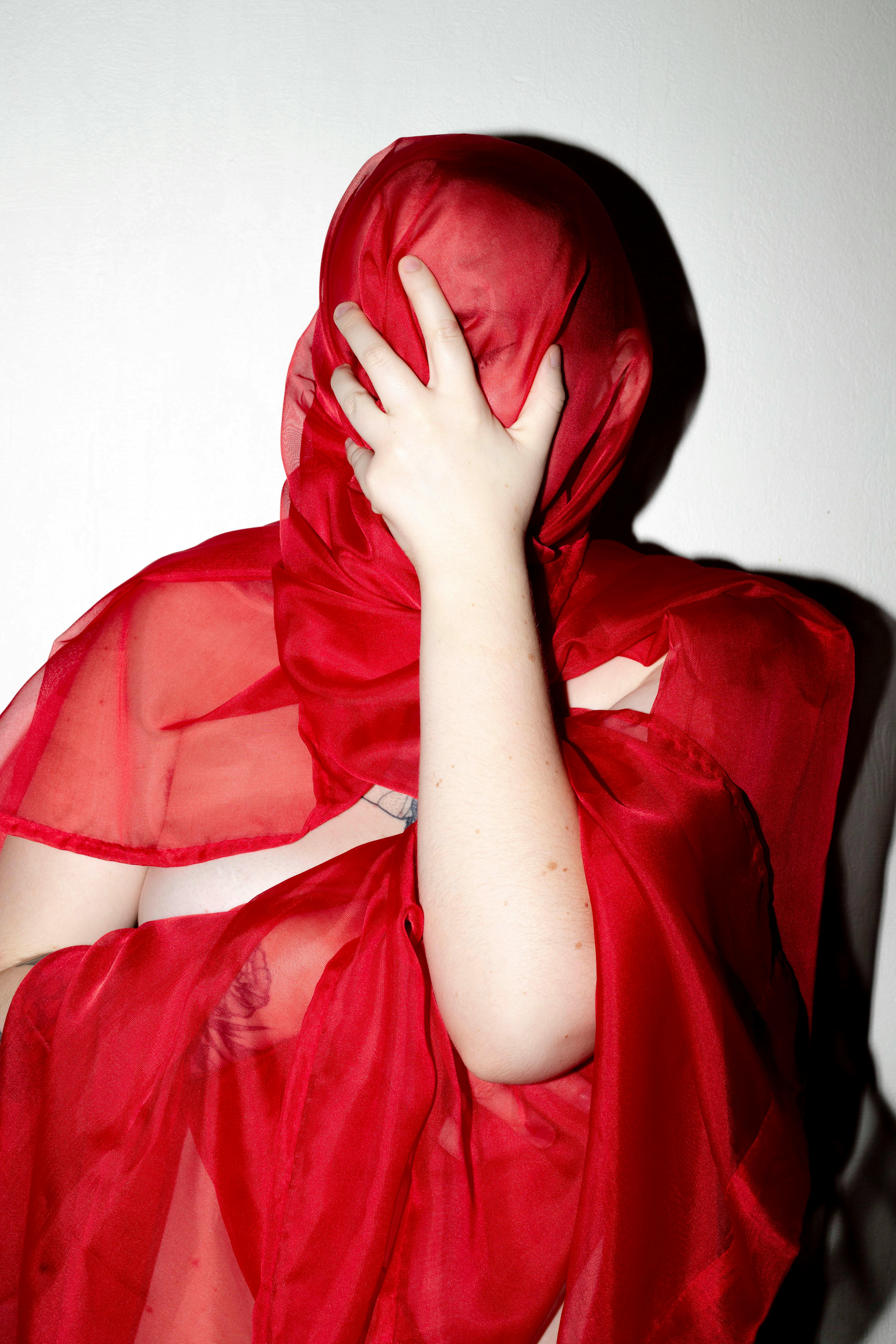 Person Covering Face with a Red Cloth · Free Stock Photo