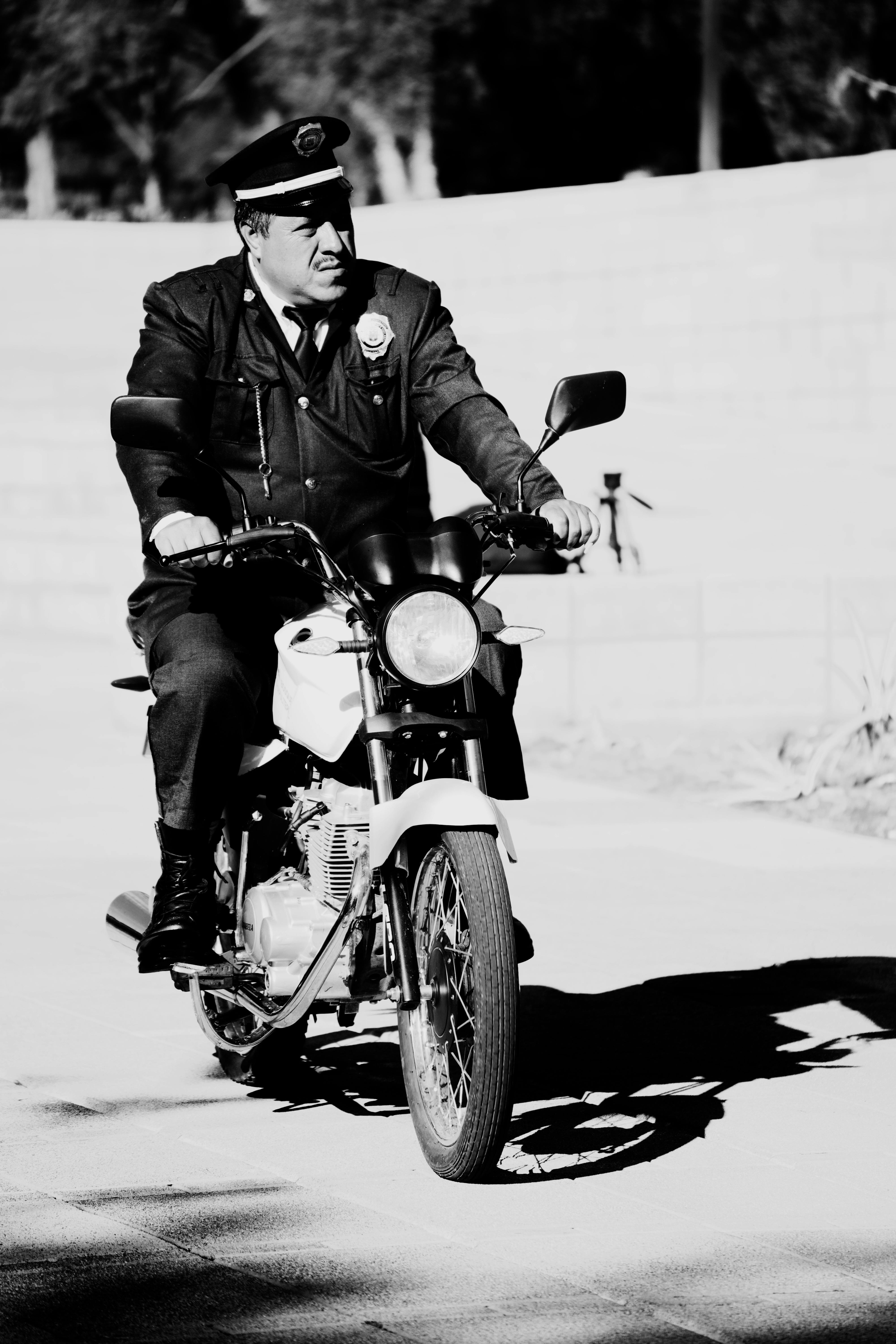 Grayscale Photo of a Police Officer Riding a Motorcycle · Free Stock Photo