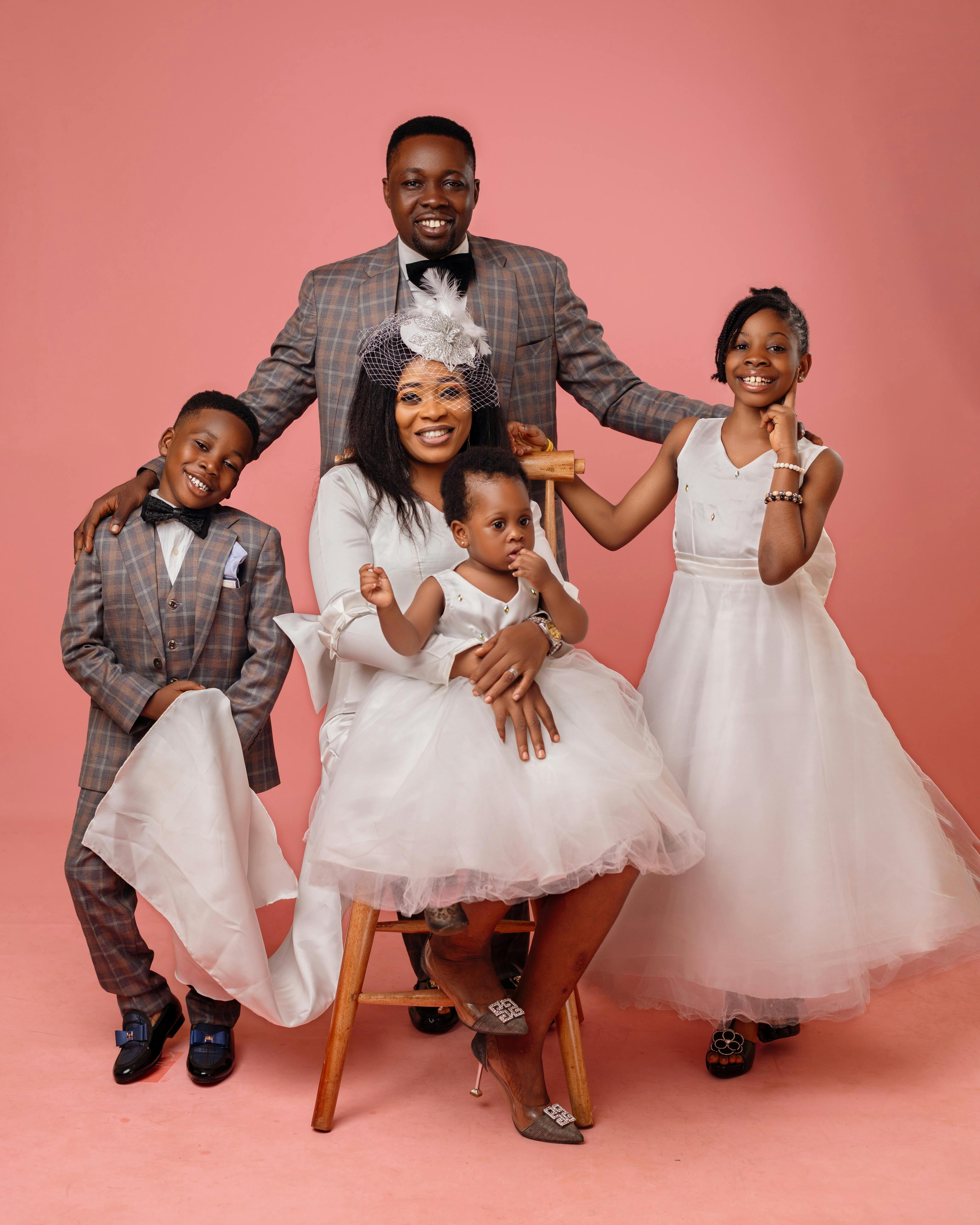 Family in Suits and Dresses Posing Together · Free Stock Photo