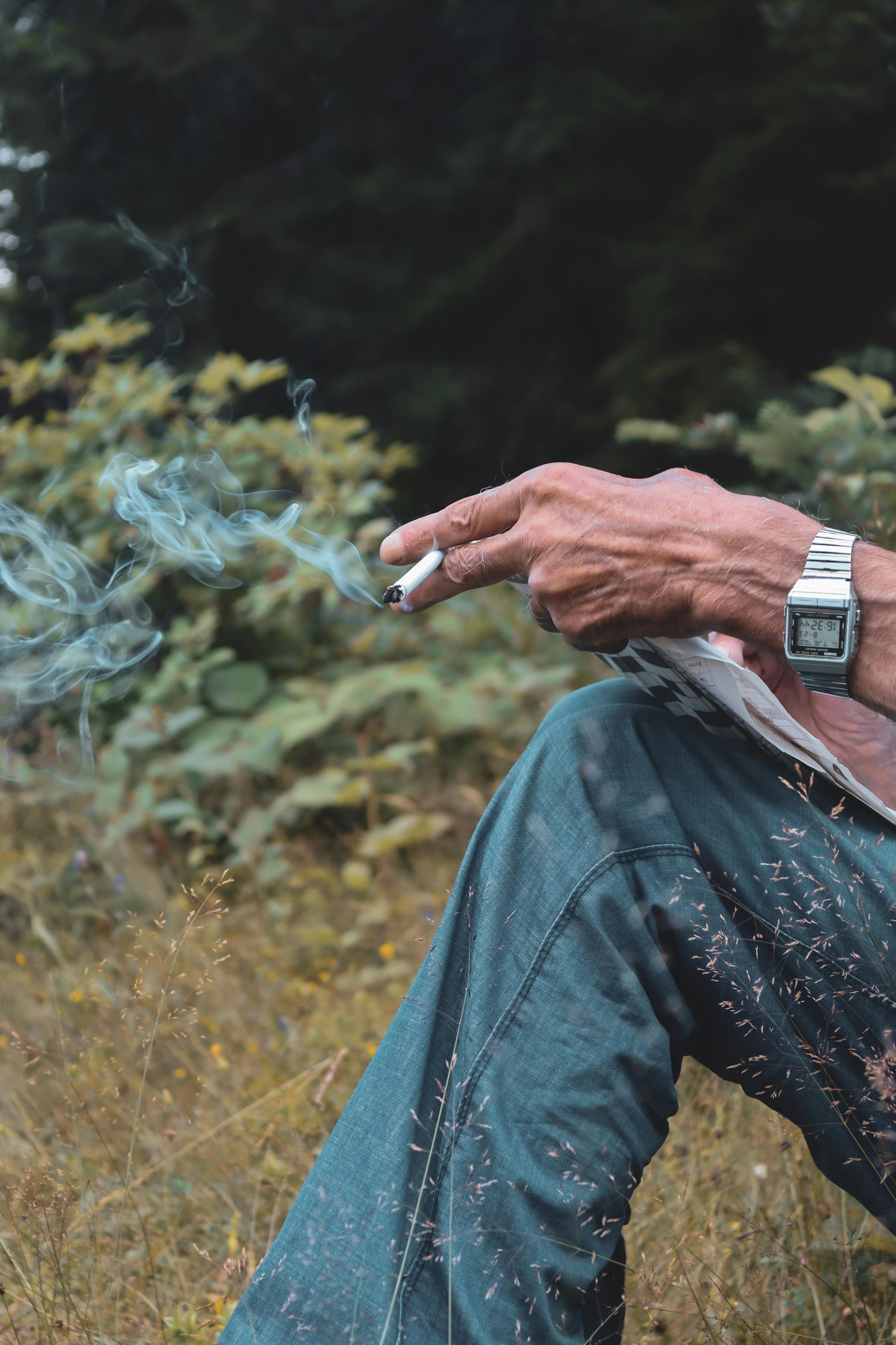 Close-Up Shot of a Person Smoking Cigarette · Free Stock Photo