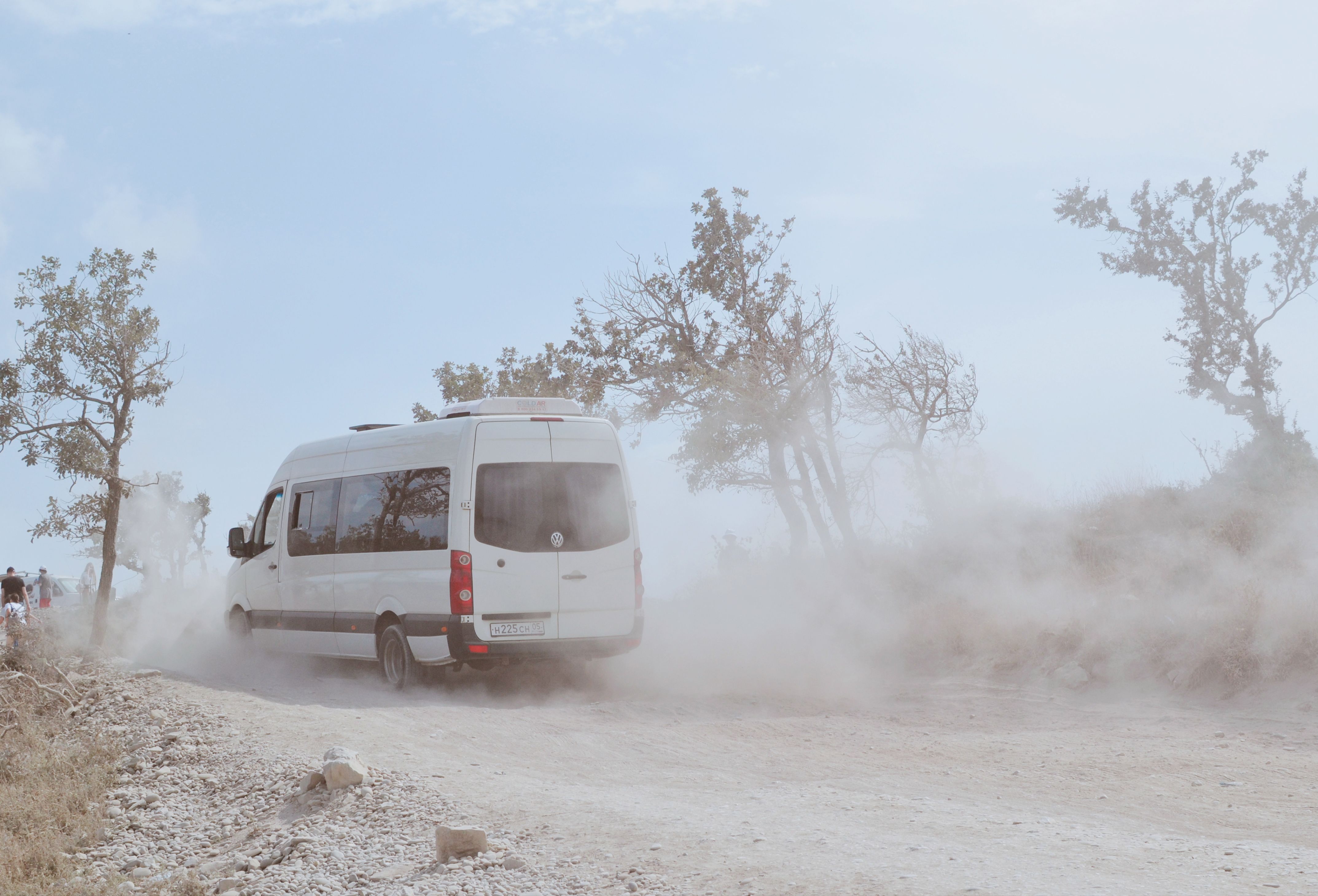 White Van on Dusty Road · Free Stock Photo