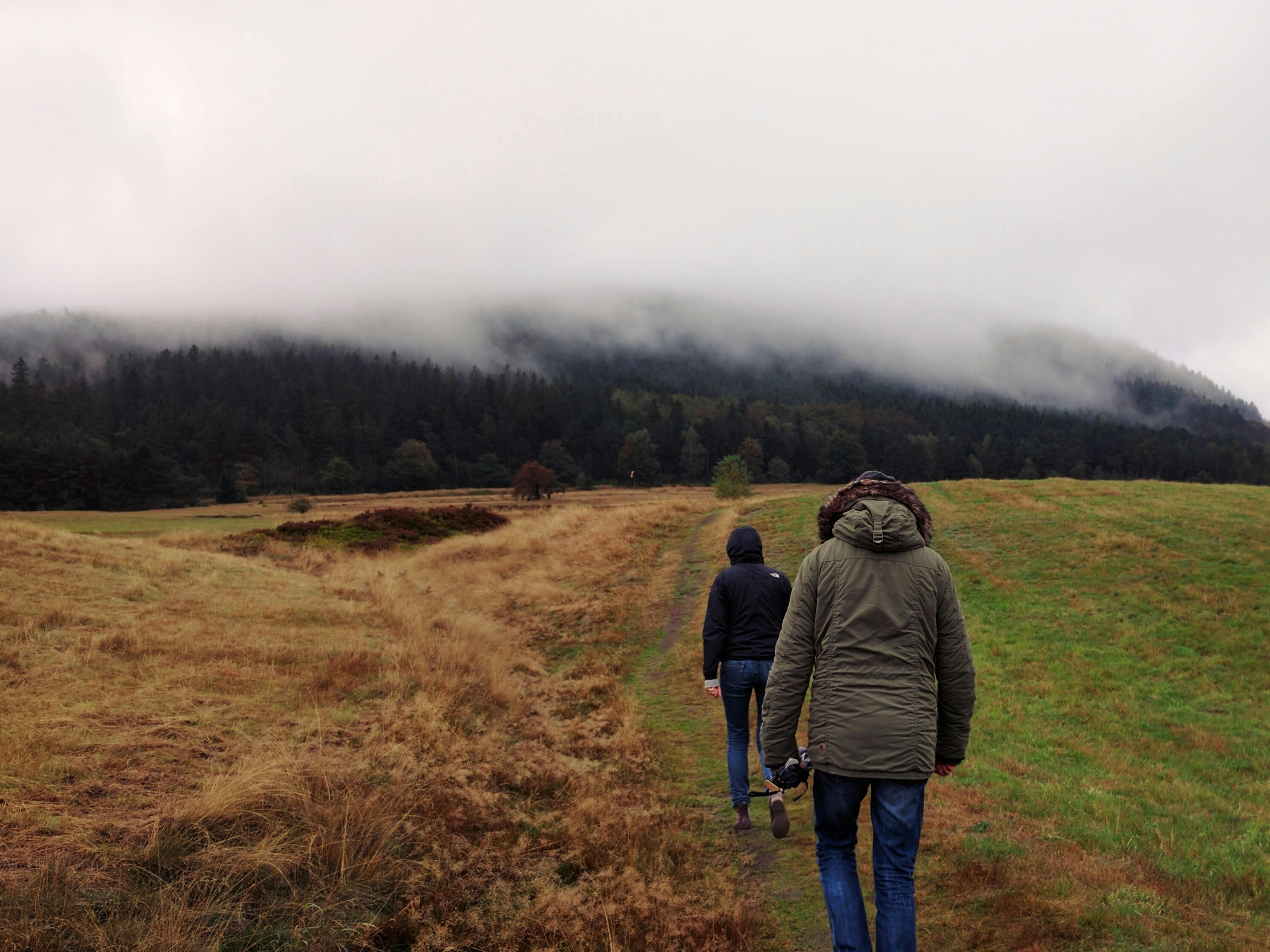 Two People Walking On Field · Free Stock Photo