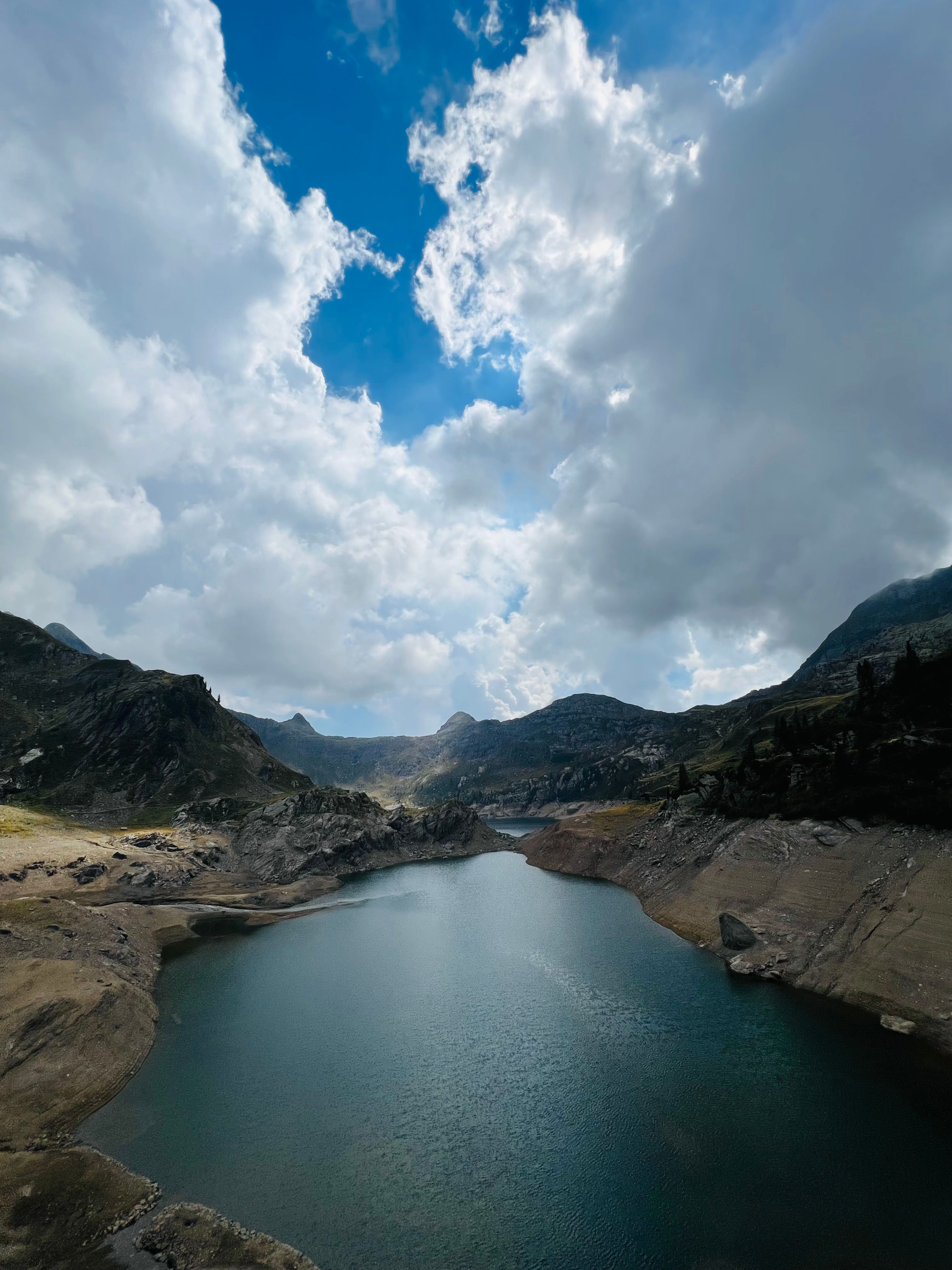 Blue Lake Between Mountains Under White Clouds · Free Stock Photo