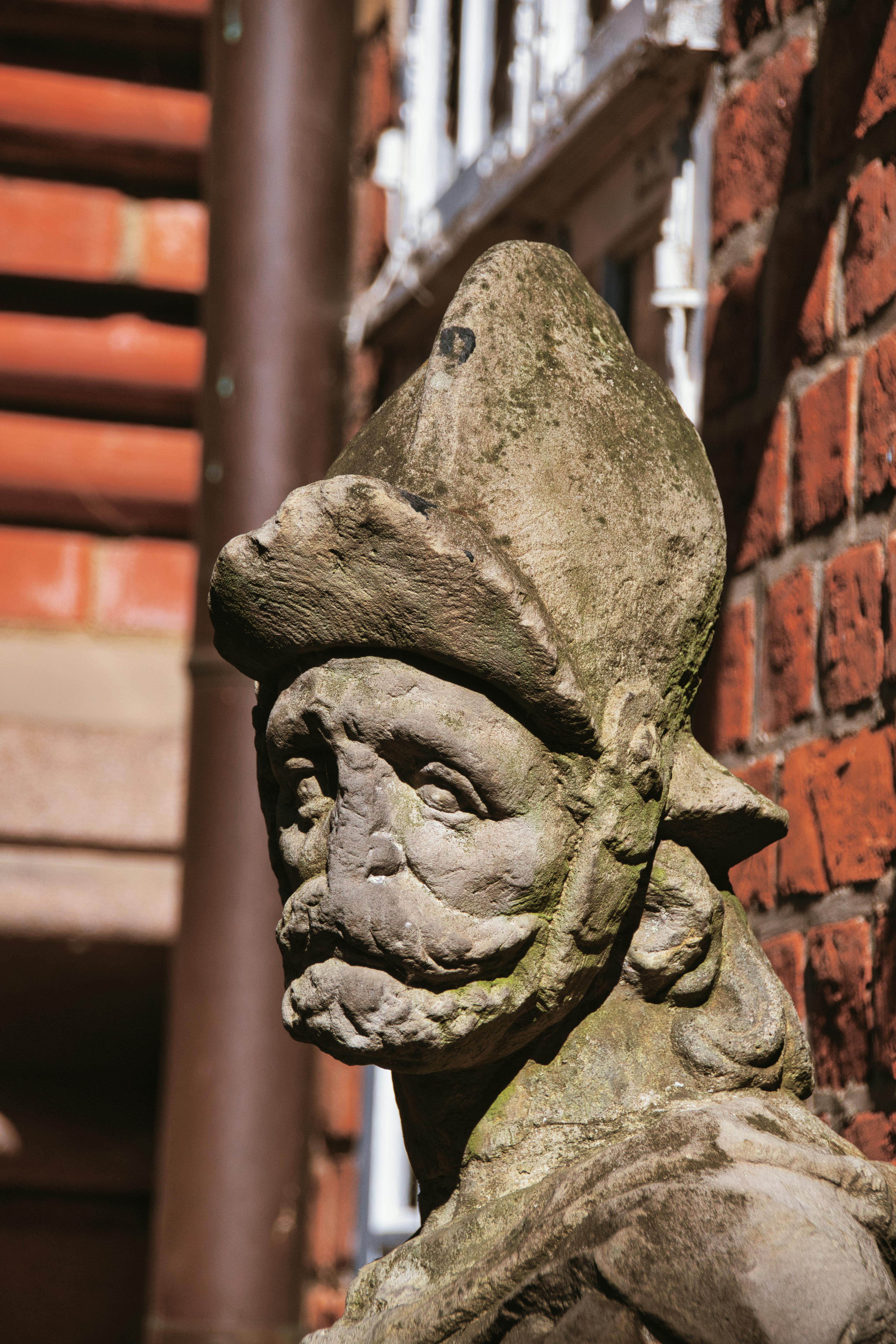 Scary Statue on Gray Concrete Wall · Free Stock Photo