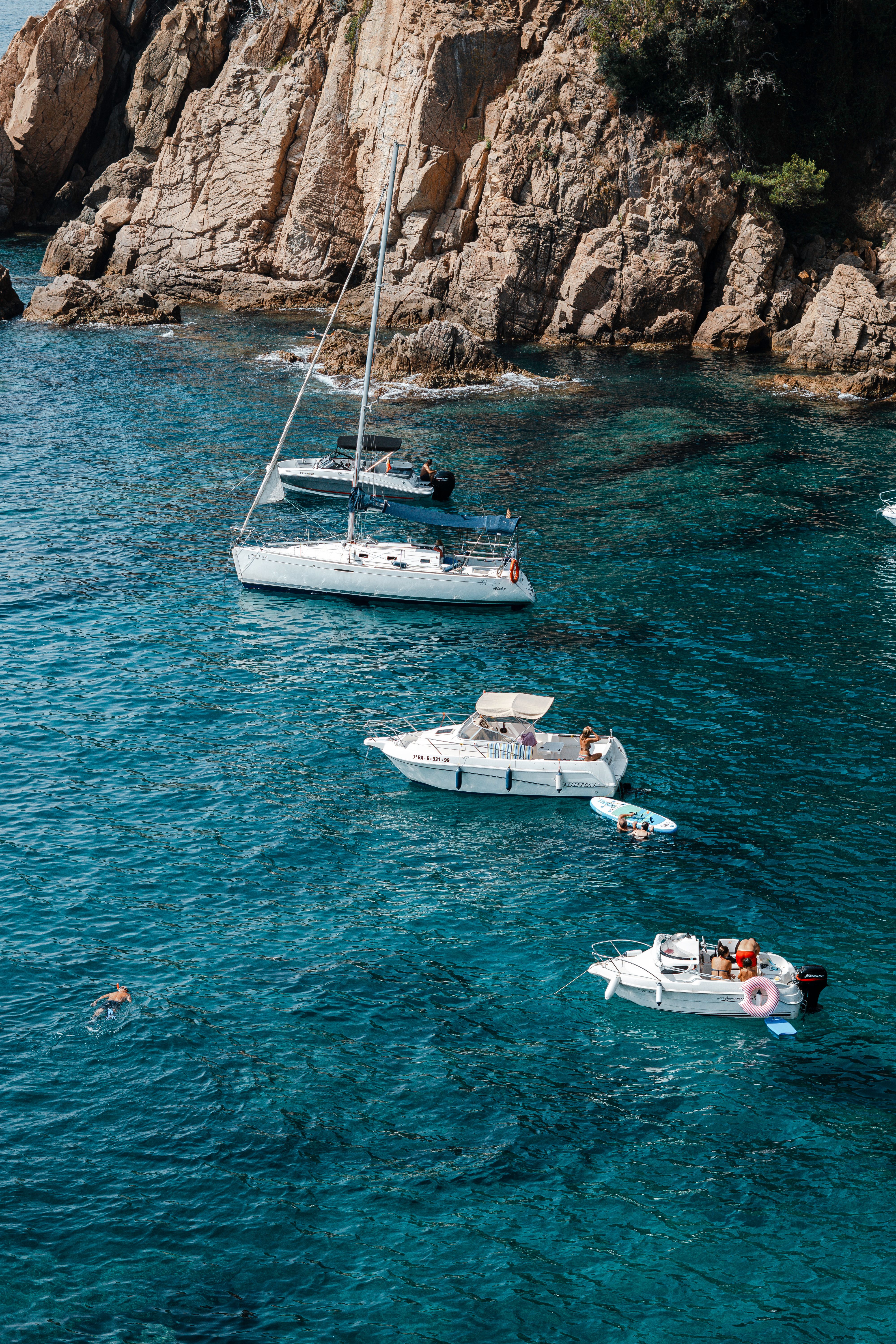 Boats Sailing in Turquoise Water Near a Cliff · Free Stock Photo