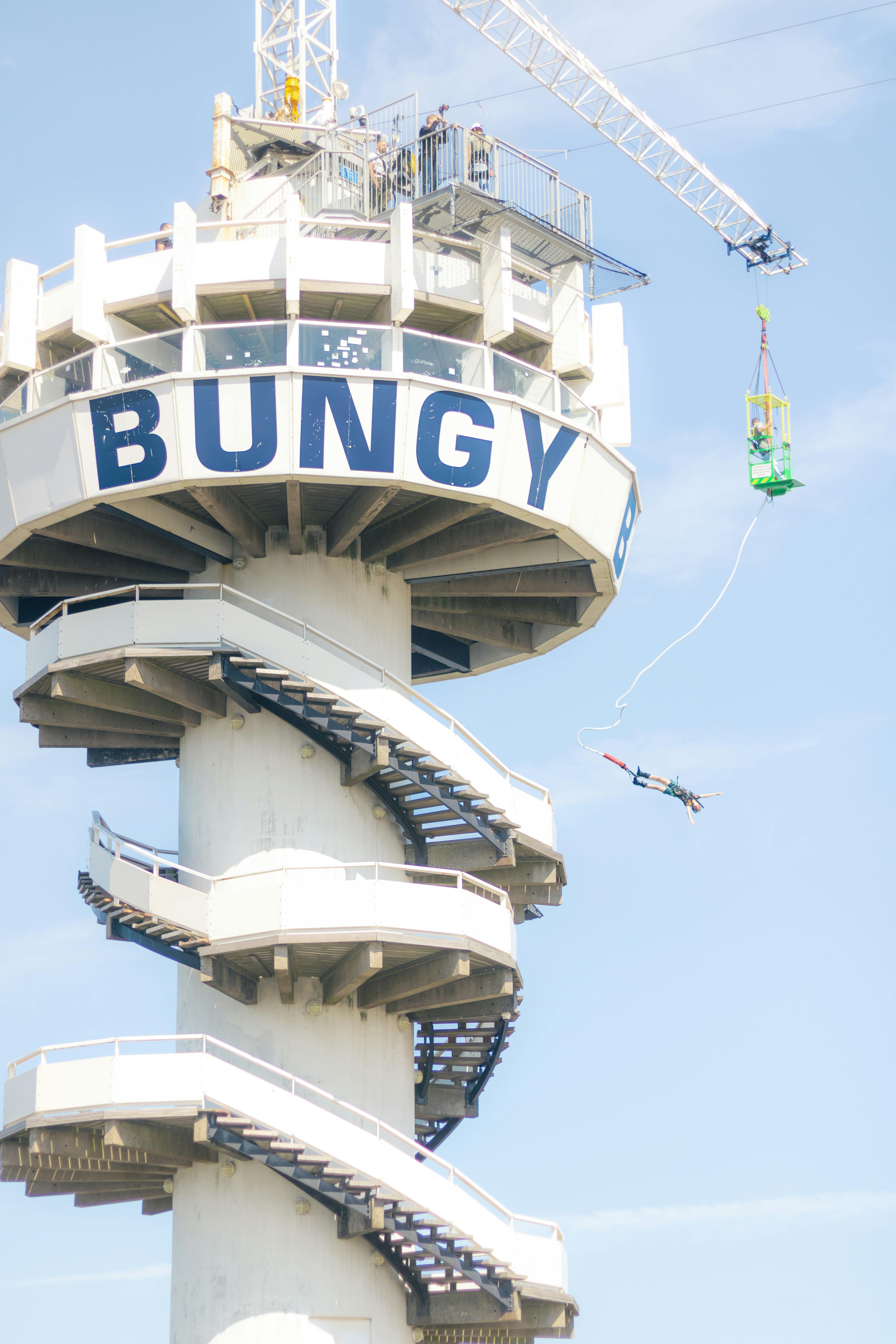 People Doing Bungee Jumping Near Spiral Staircase · Free Stock Photo