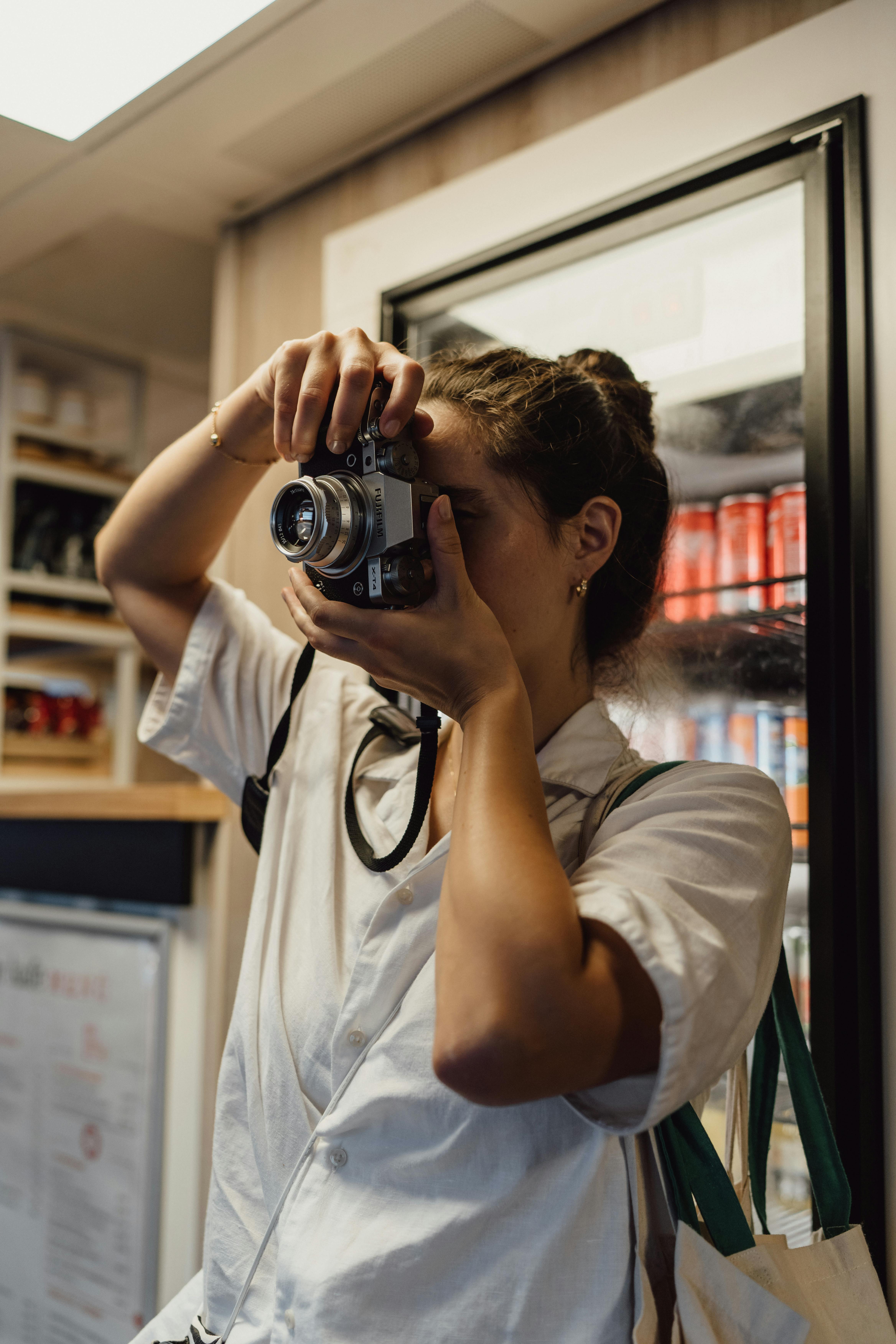 Portrait of Woman Photographing with a Camera · Free Stock Photo