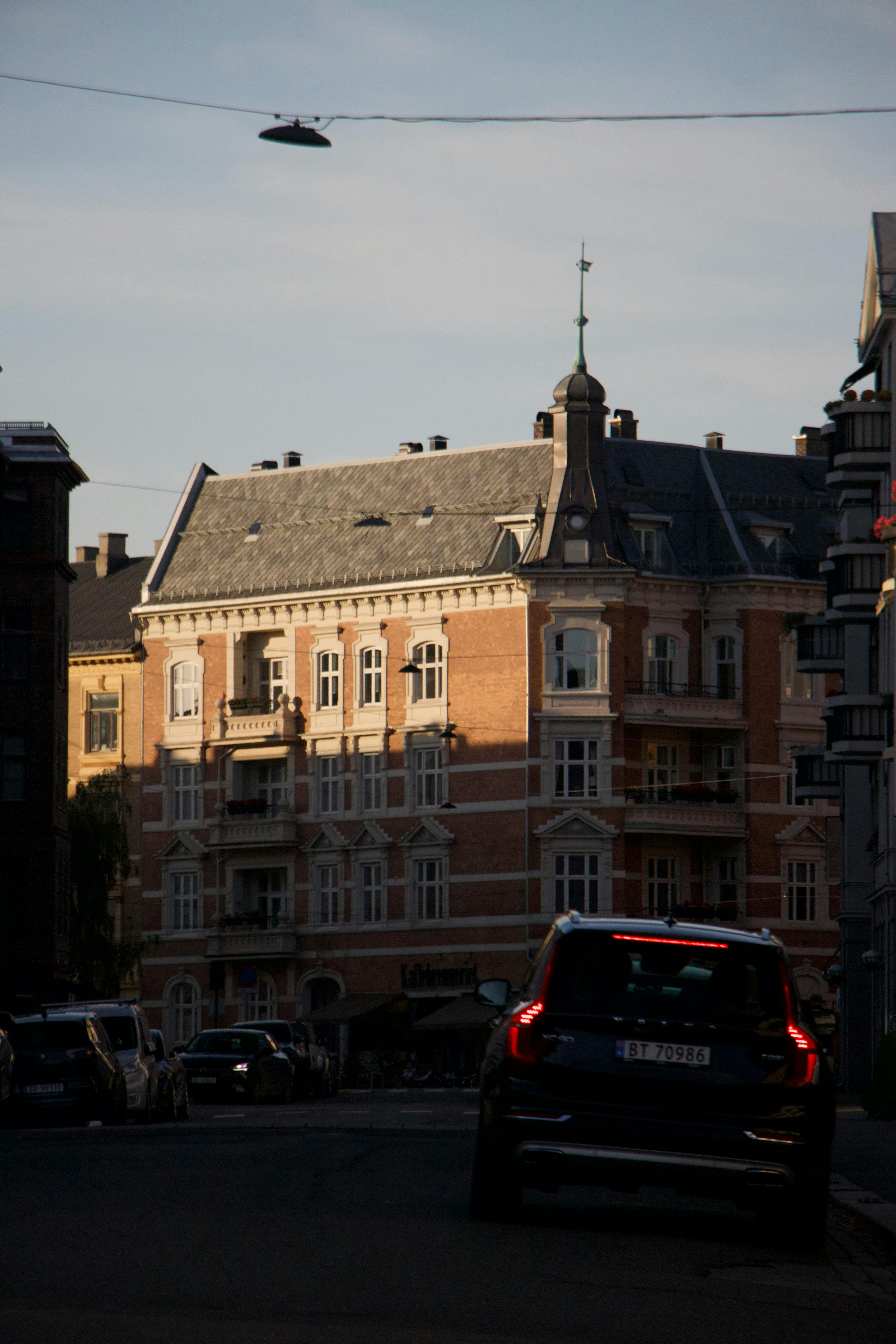 Parked Cars Between Concrete Buildings · Free Stock Photo