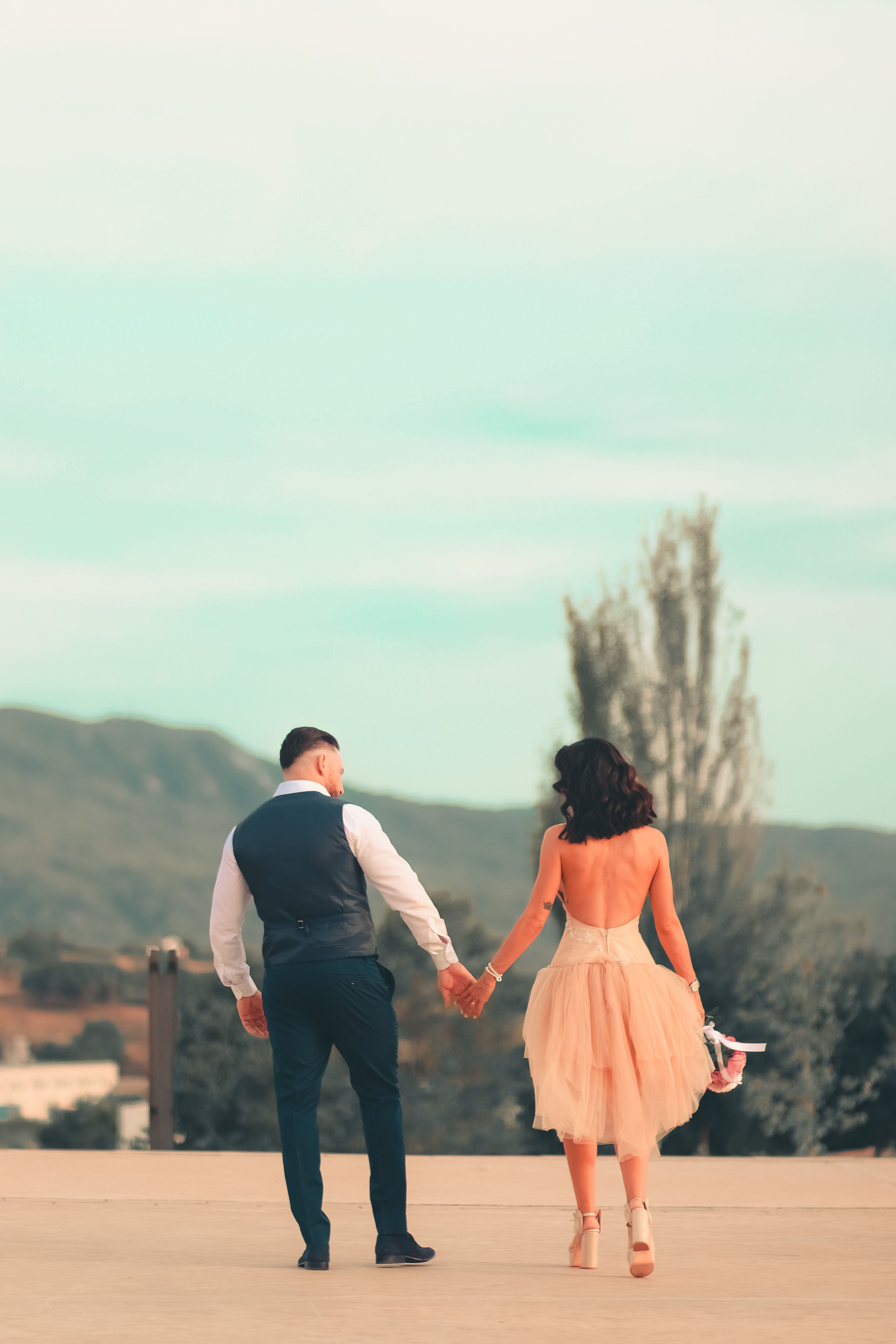 Romantic Couple Running on the Sidewalk while Holding Hands Together ...
