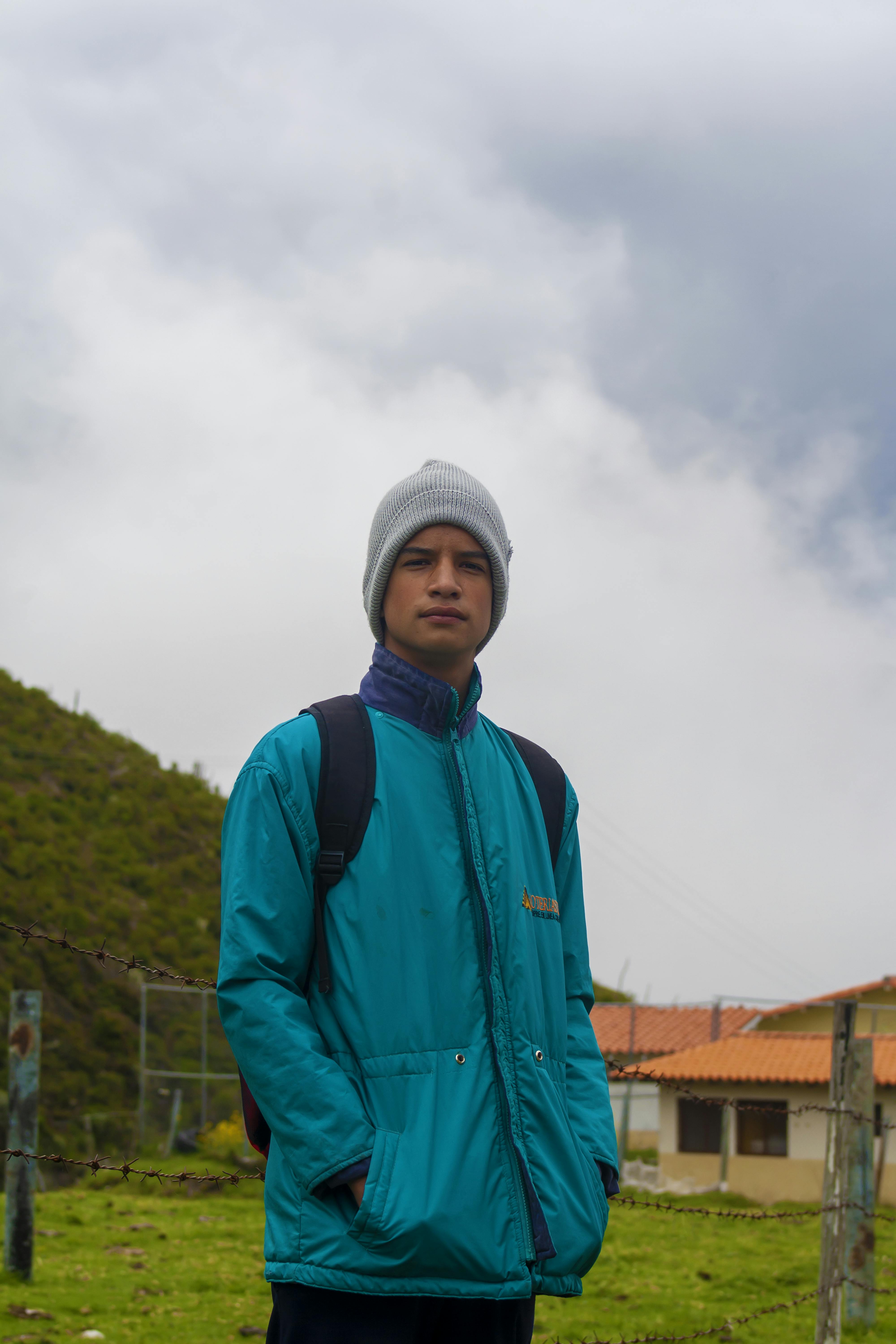A Man Wearing a Blue Jacket with Hands inside Pockets · Free Stock Photo