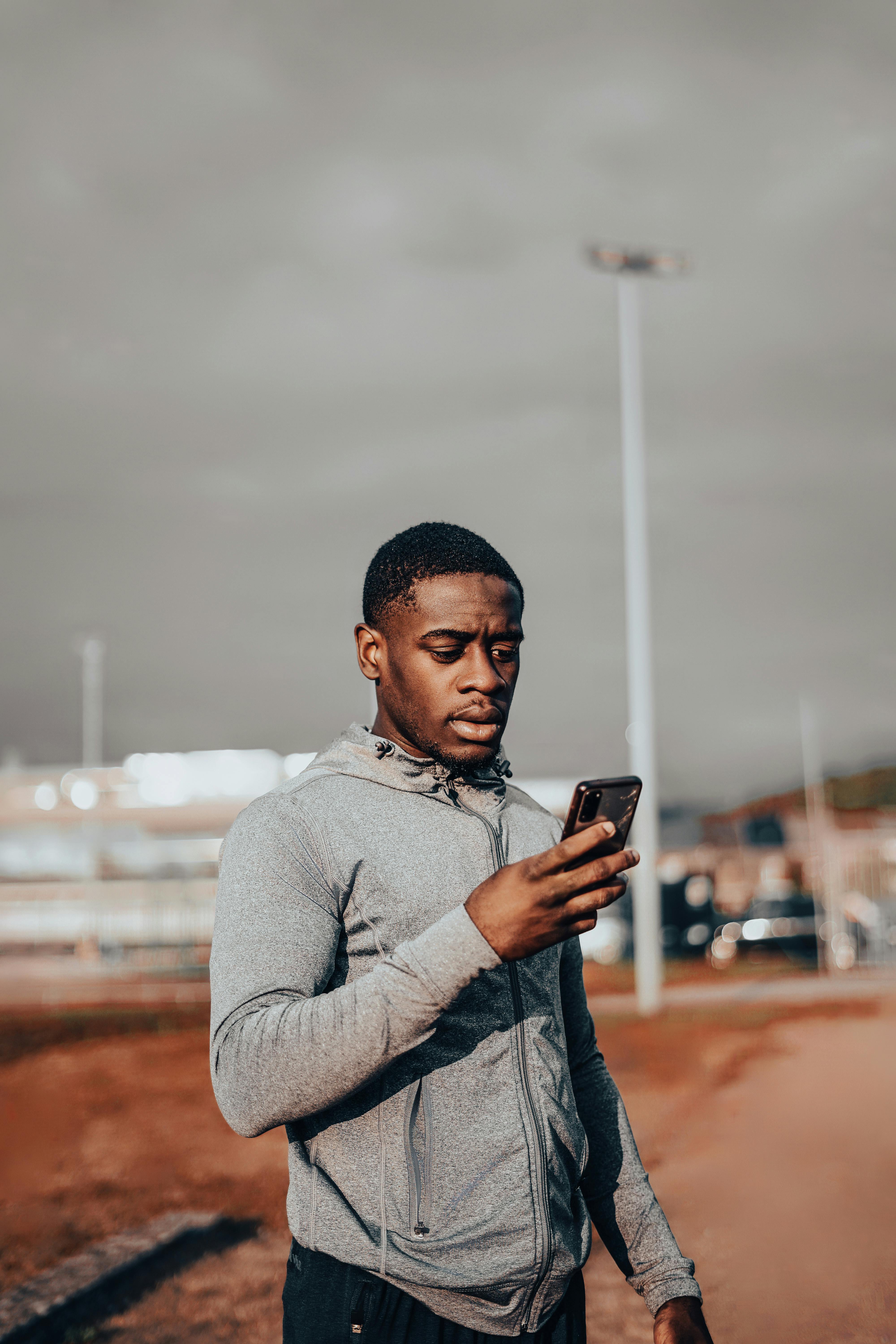 Man Using Cellphone Outdoors · Free Stock Photo