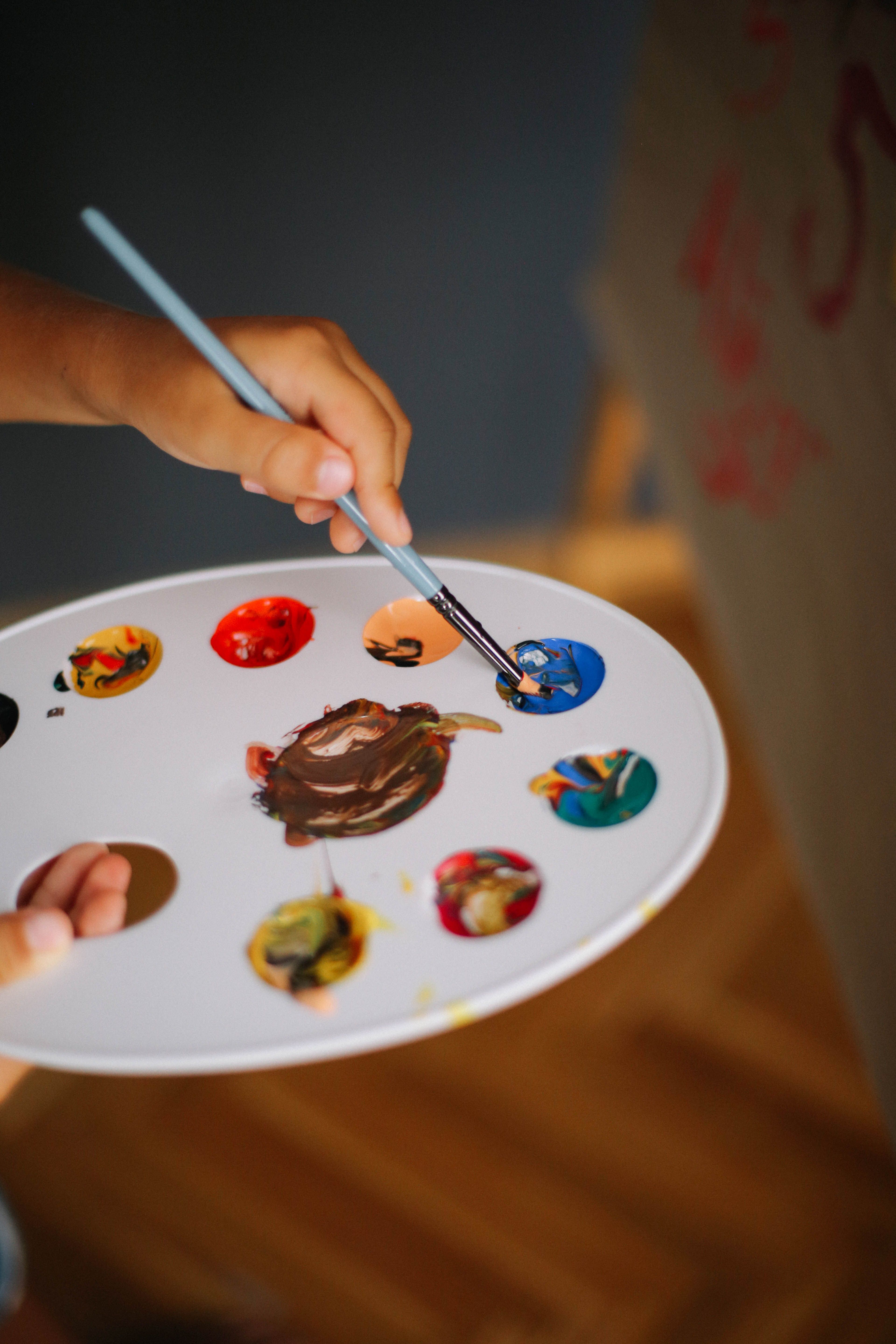 A Close-Up Shot of a Person Holding a Paint Brush · Free Stock Photo