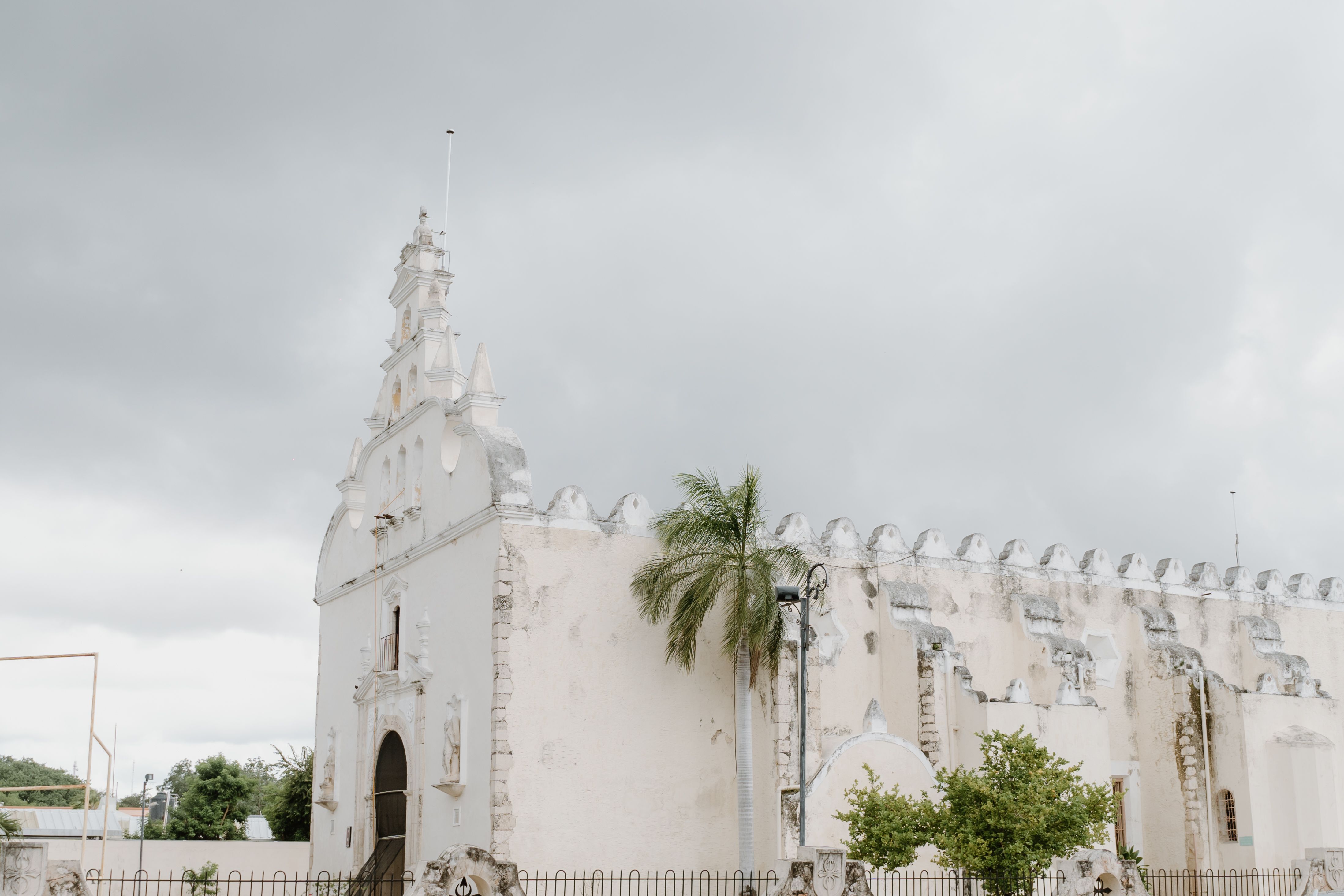 A Church Beside Brown Concrete Building · Free Stock Photo