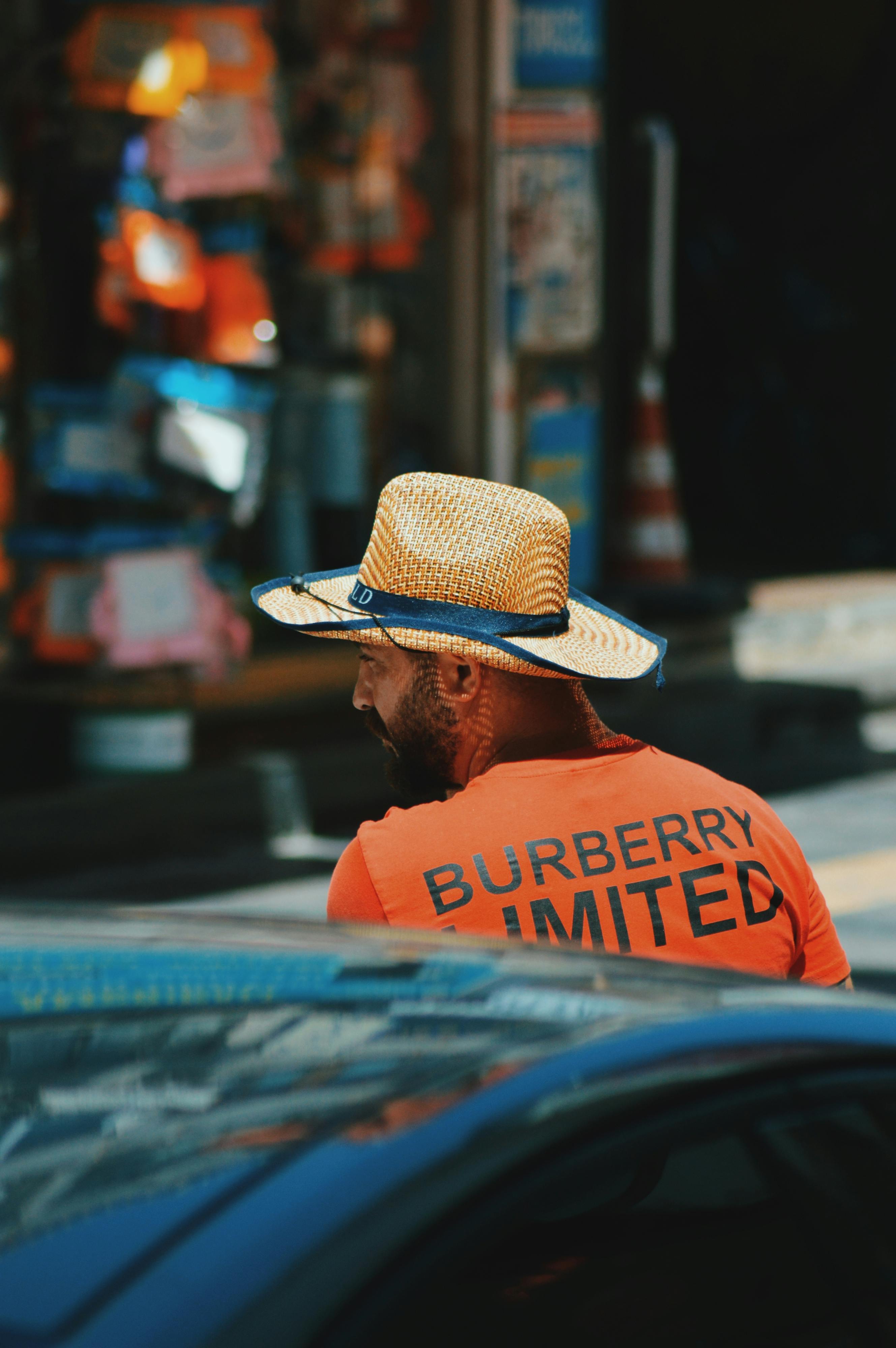 Man Wearing a Cowboy Hat Bending under Wooden Beams · Free Stock Photo