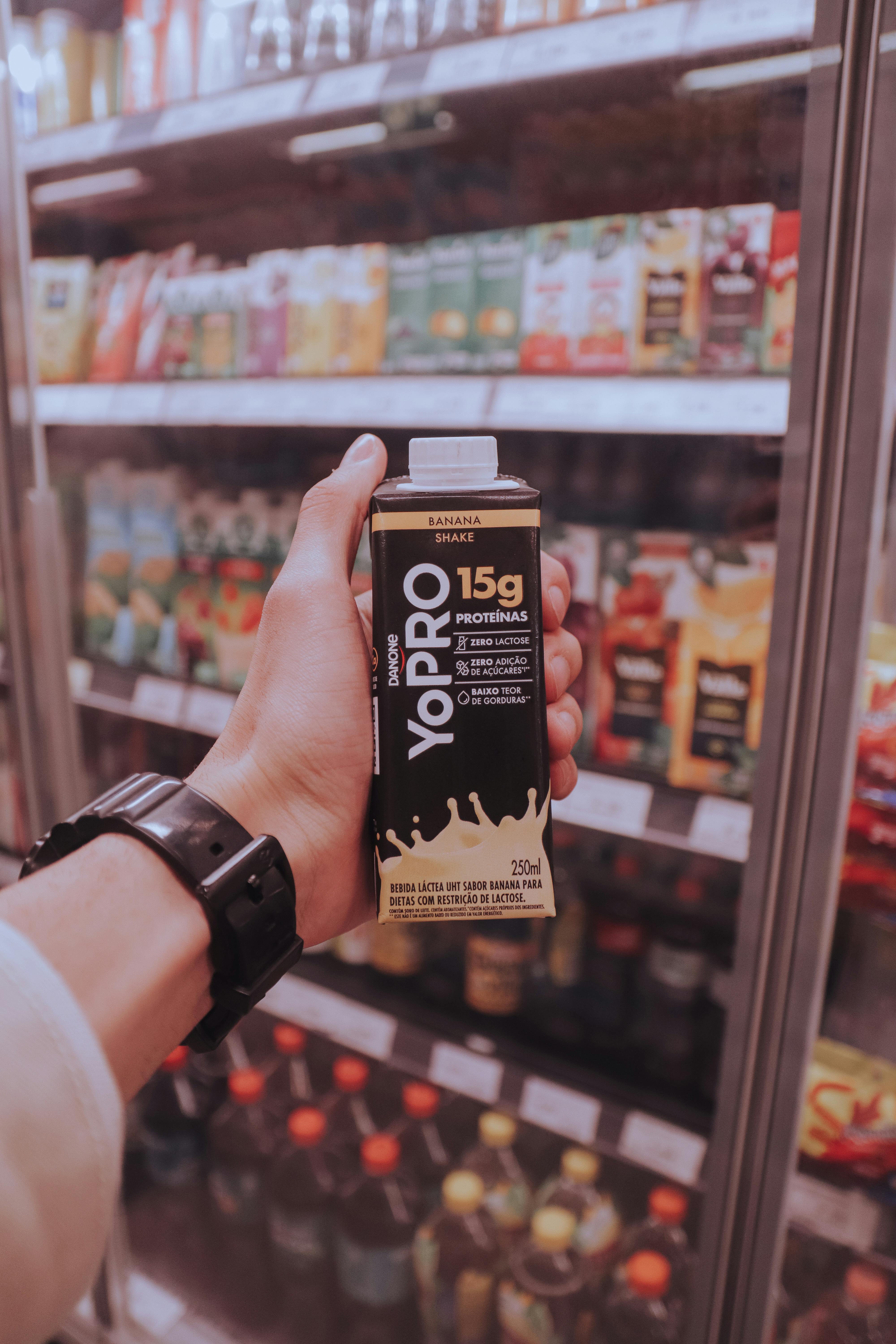 Close-Up Shot of a Person Holding a YoPRO Banana Protein Shake · Free ...