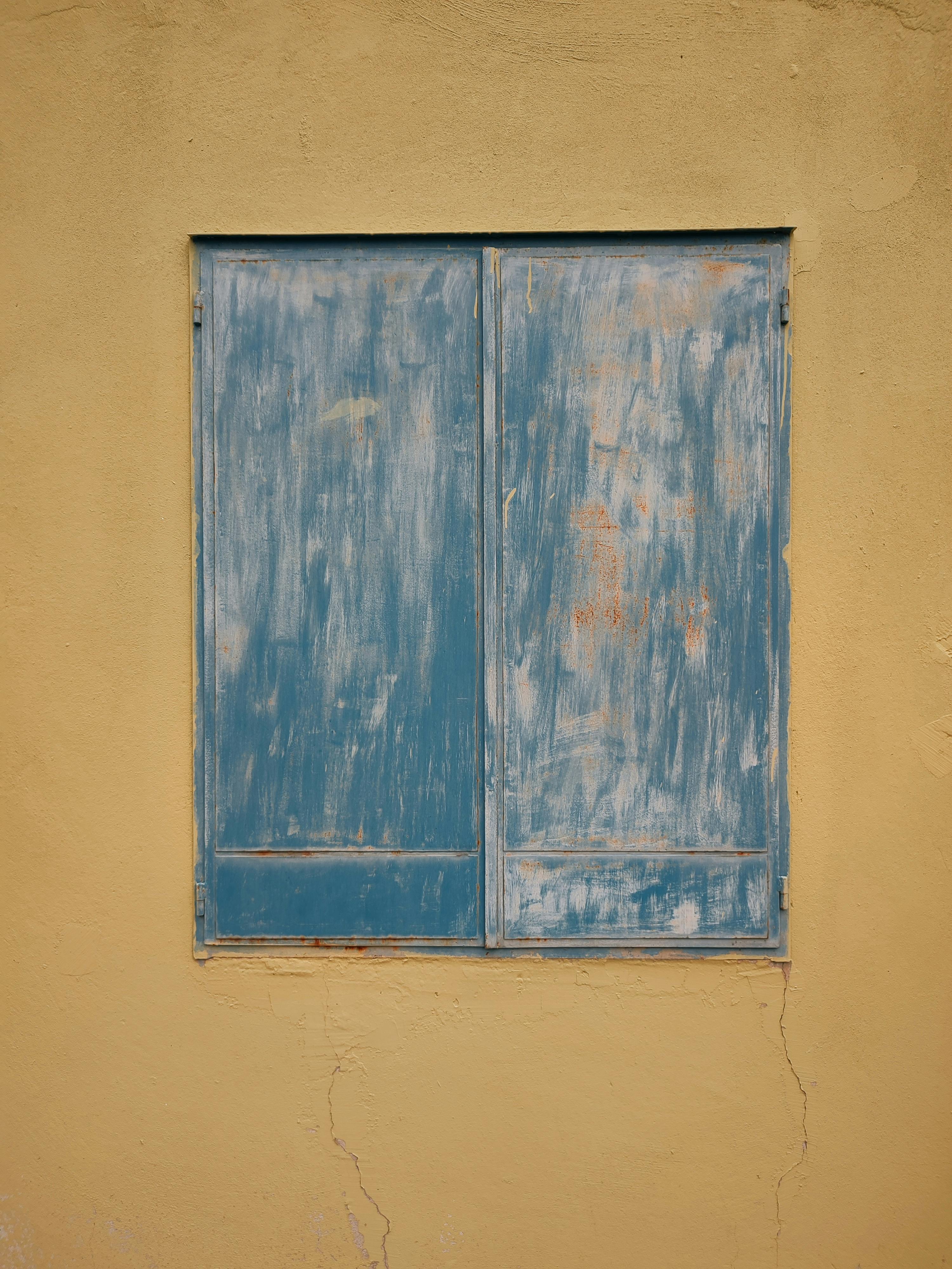 A Closed Window of a Concrete Building · Free Stock Photo