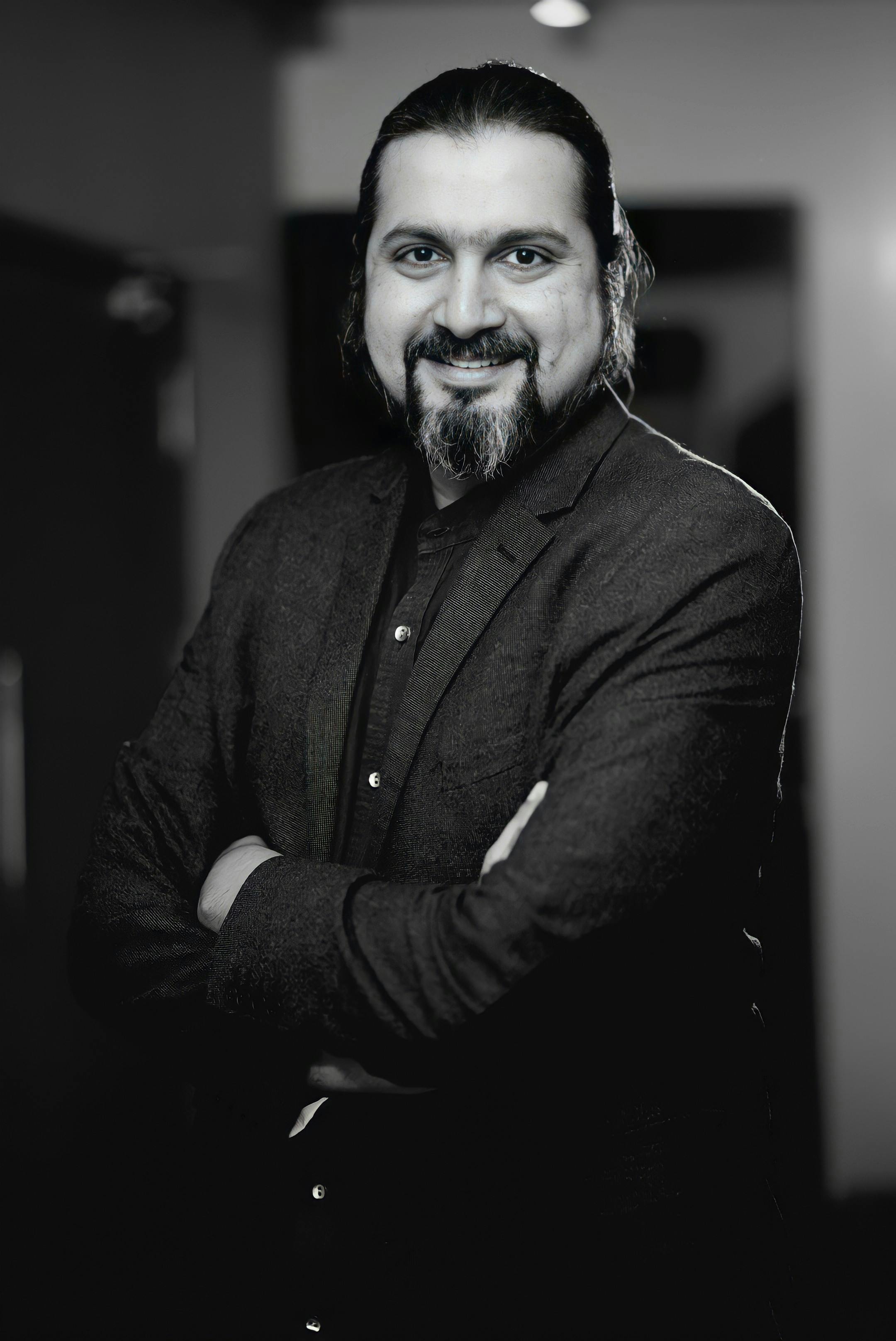 Grayscale Photograph of a Man Touching His Beard · Free Stock Photo