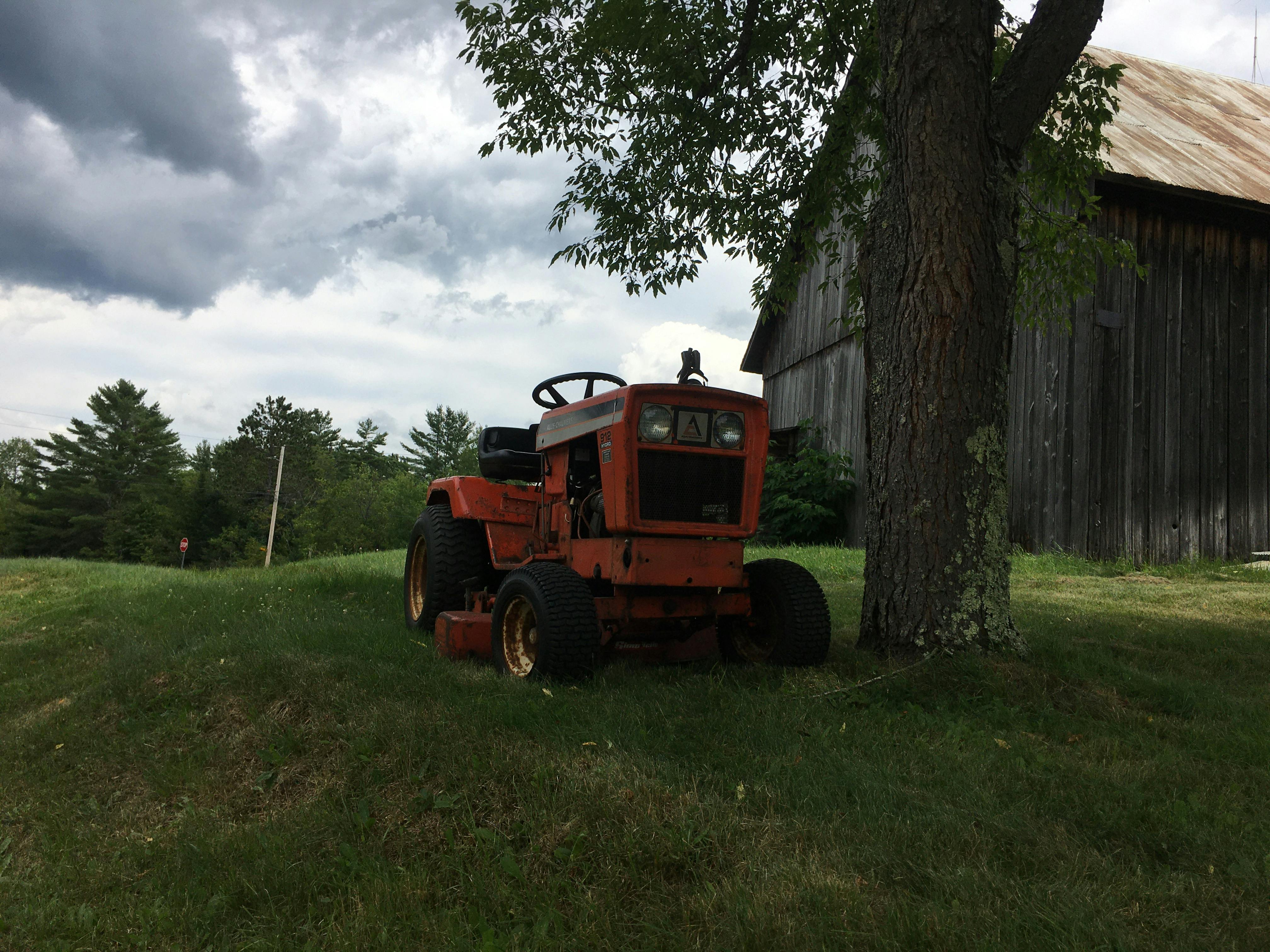 Red Tractor Under a Tree · Free Stock Photo