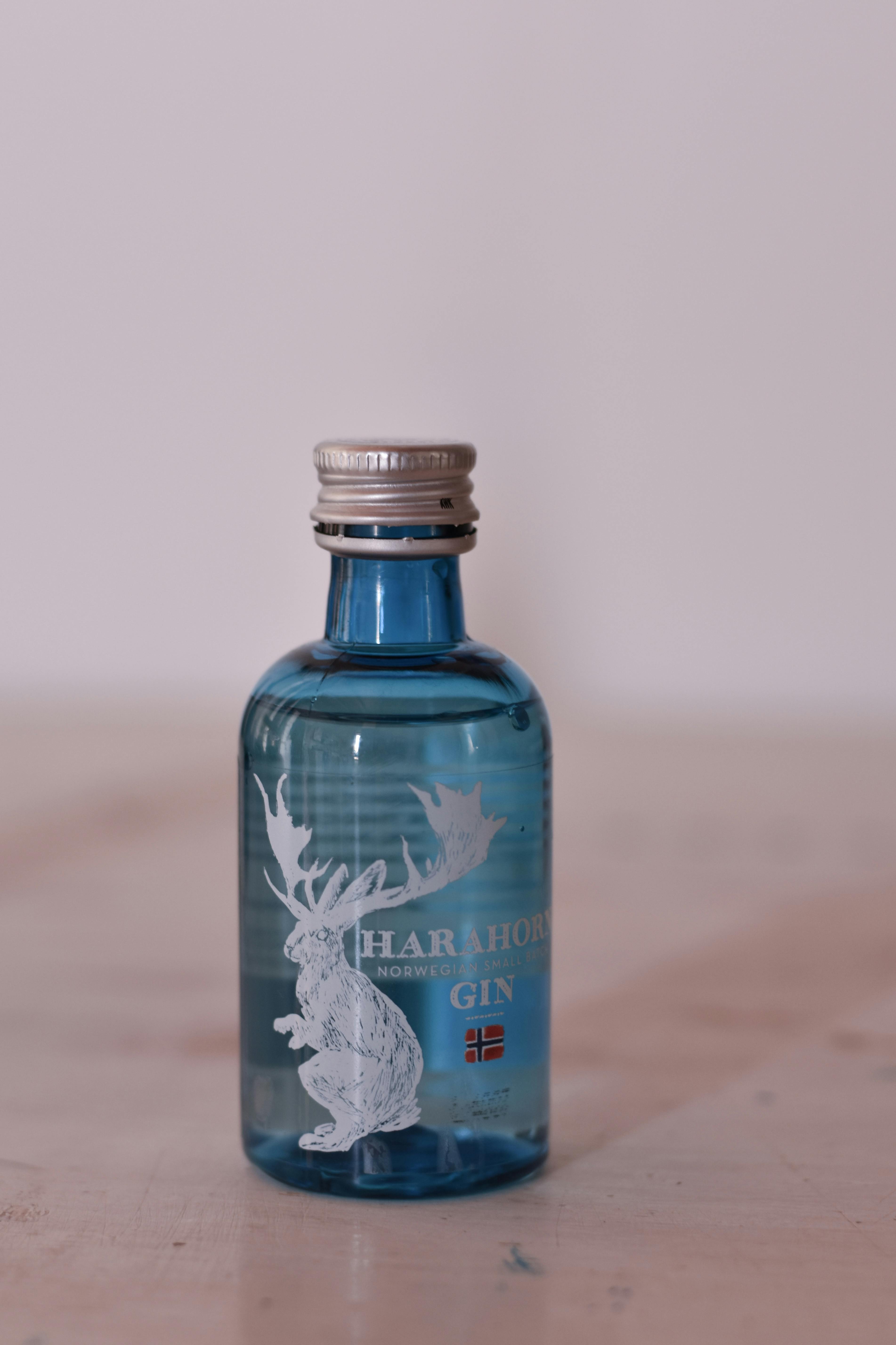 Blue Labelled Bottle on a White Surface · Free Stock Photo