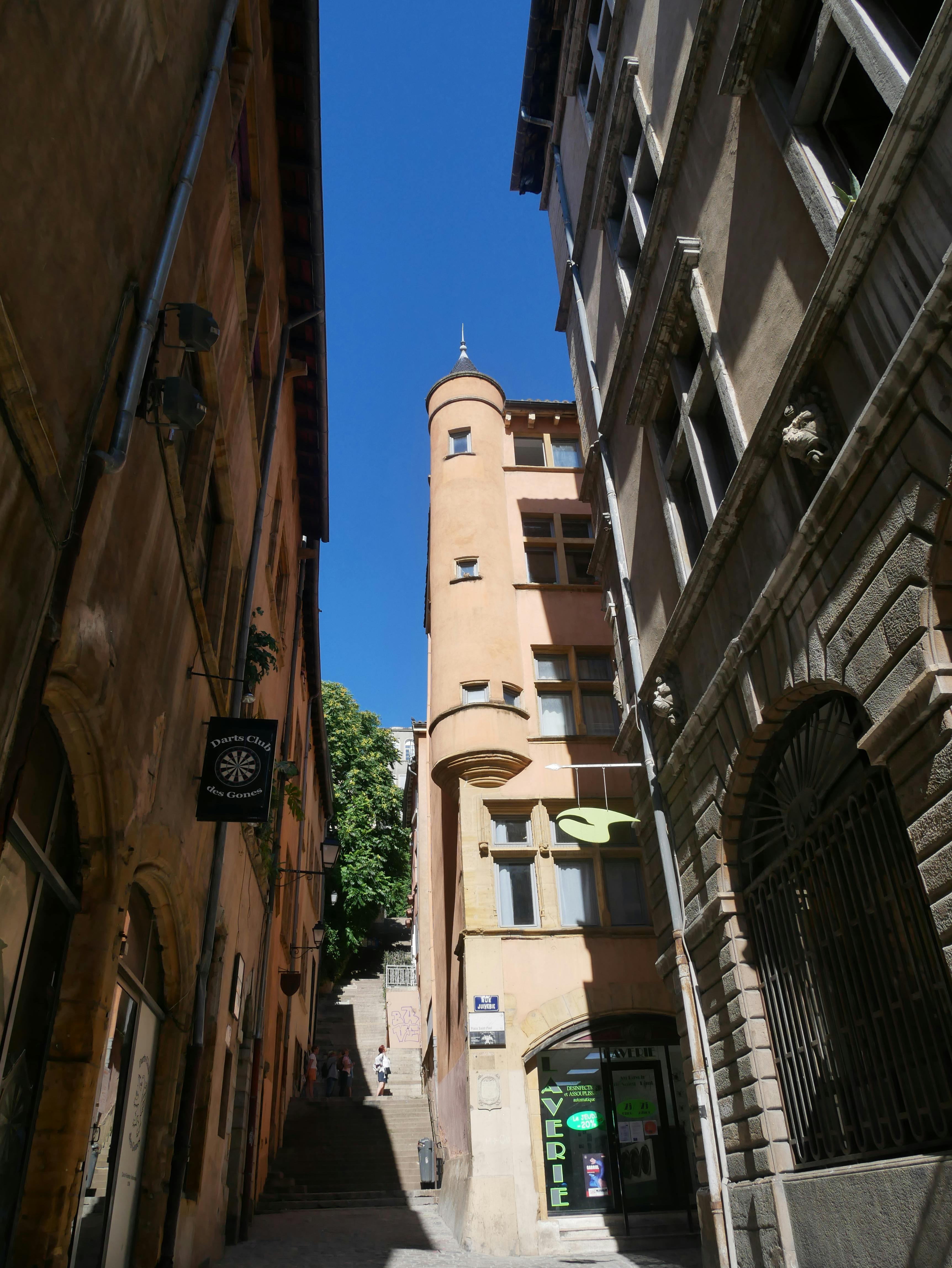 A Narrow Alleyway Between Concrete Buildings · Free Stock Photo