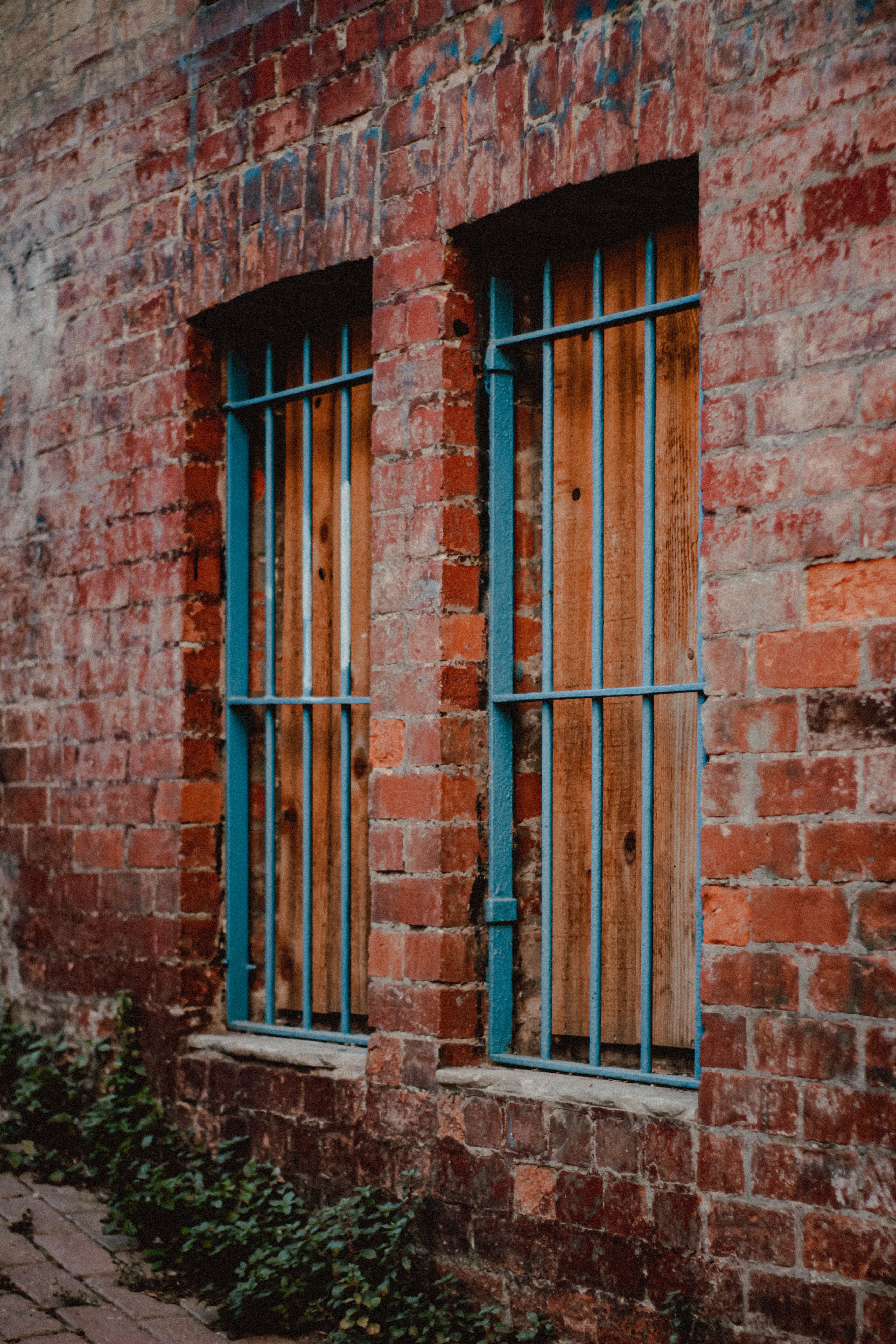 Two Window Metal Grills on a Brick Wall · Free Stock Photo