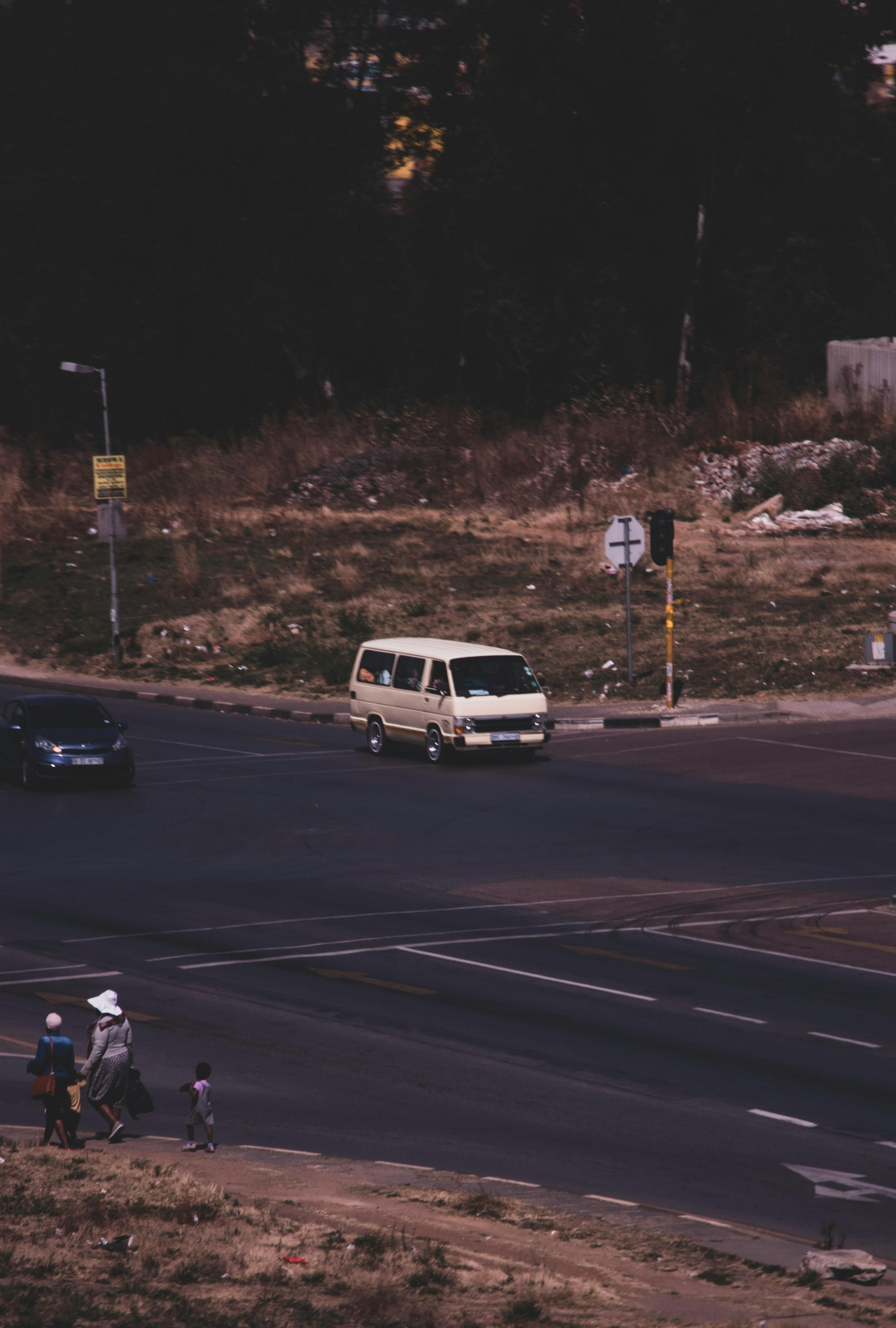 Vehicles Driving through Intersection in Country · Free Stock Photo