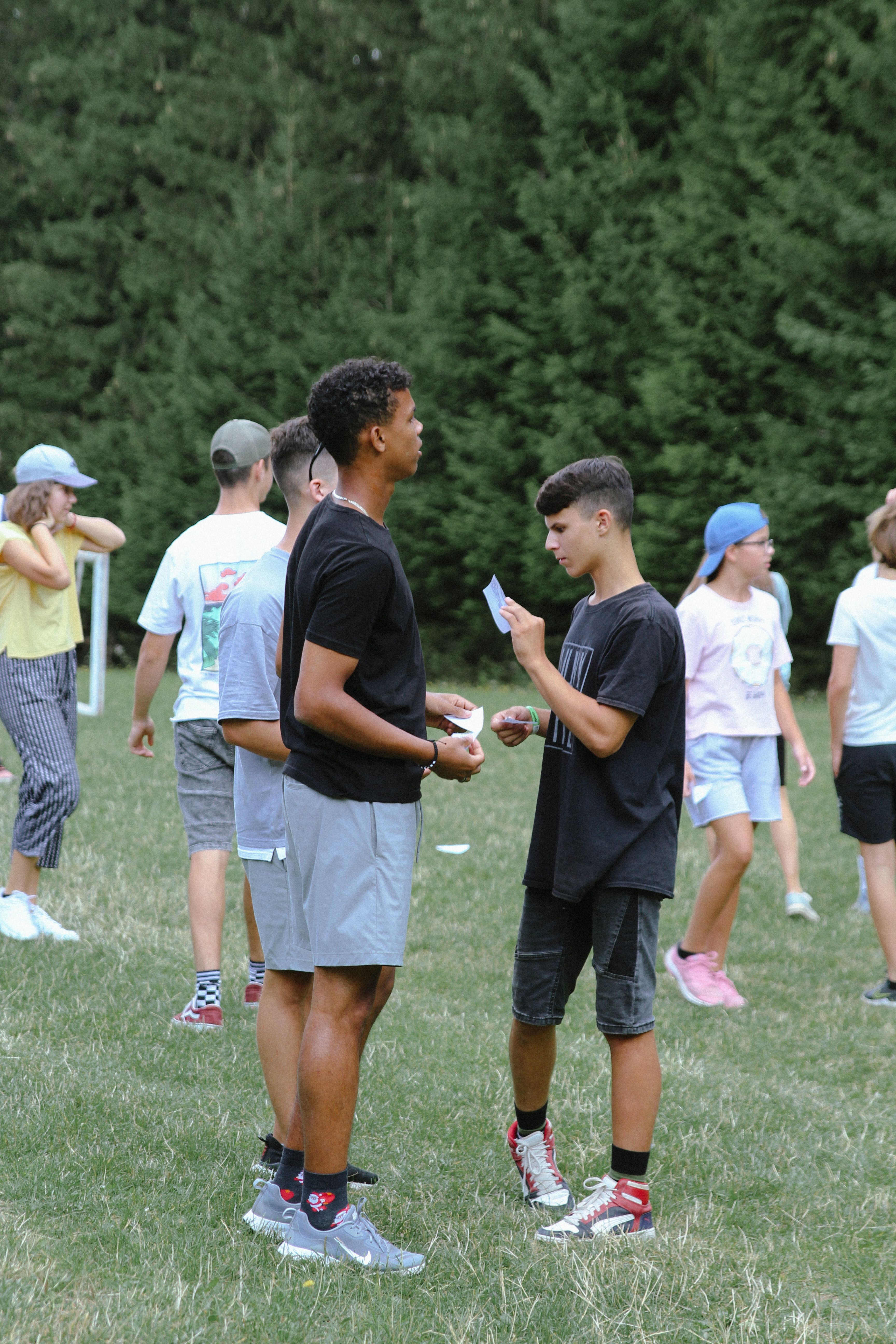 Teenagers Playing a Social Game on a Grass Field · Free Stock Photo