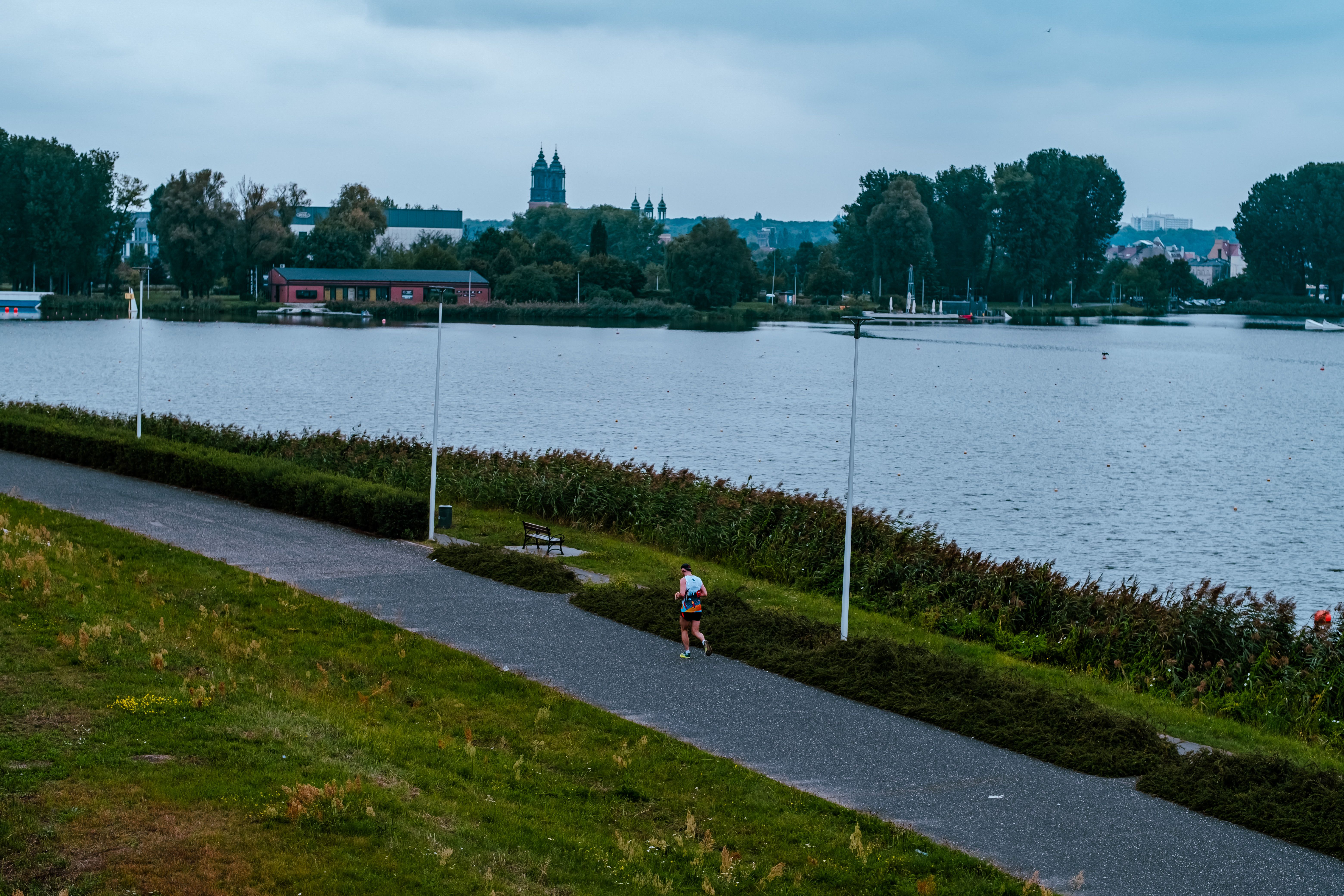 Man Jogging on a Pathway Near Body of Water · Free Stock Photo