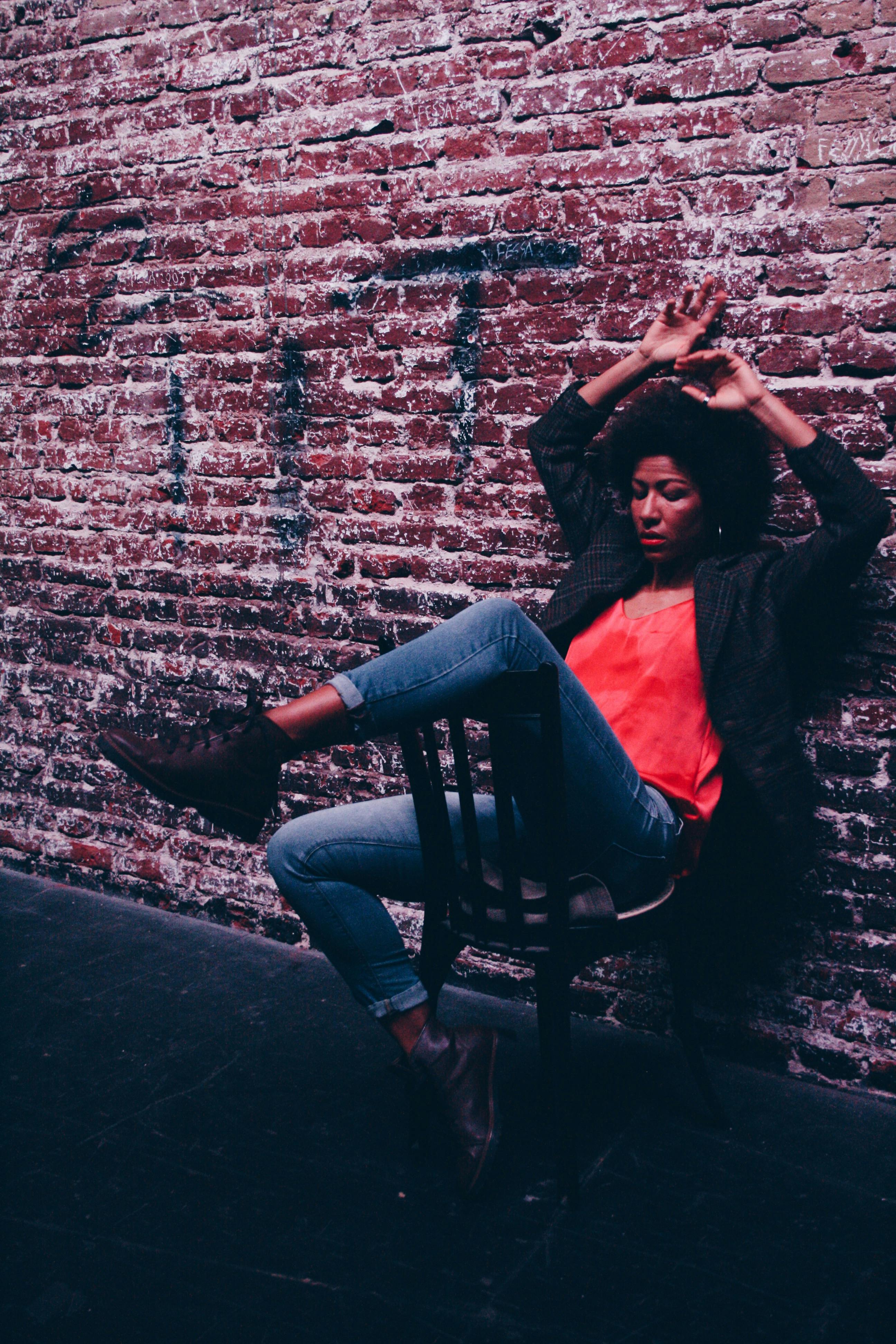 A Woman with Afro Hair Sitting on the Chair · Free Stock Photo