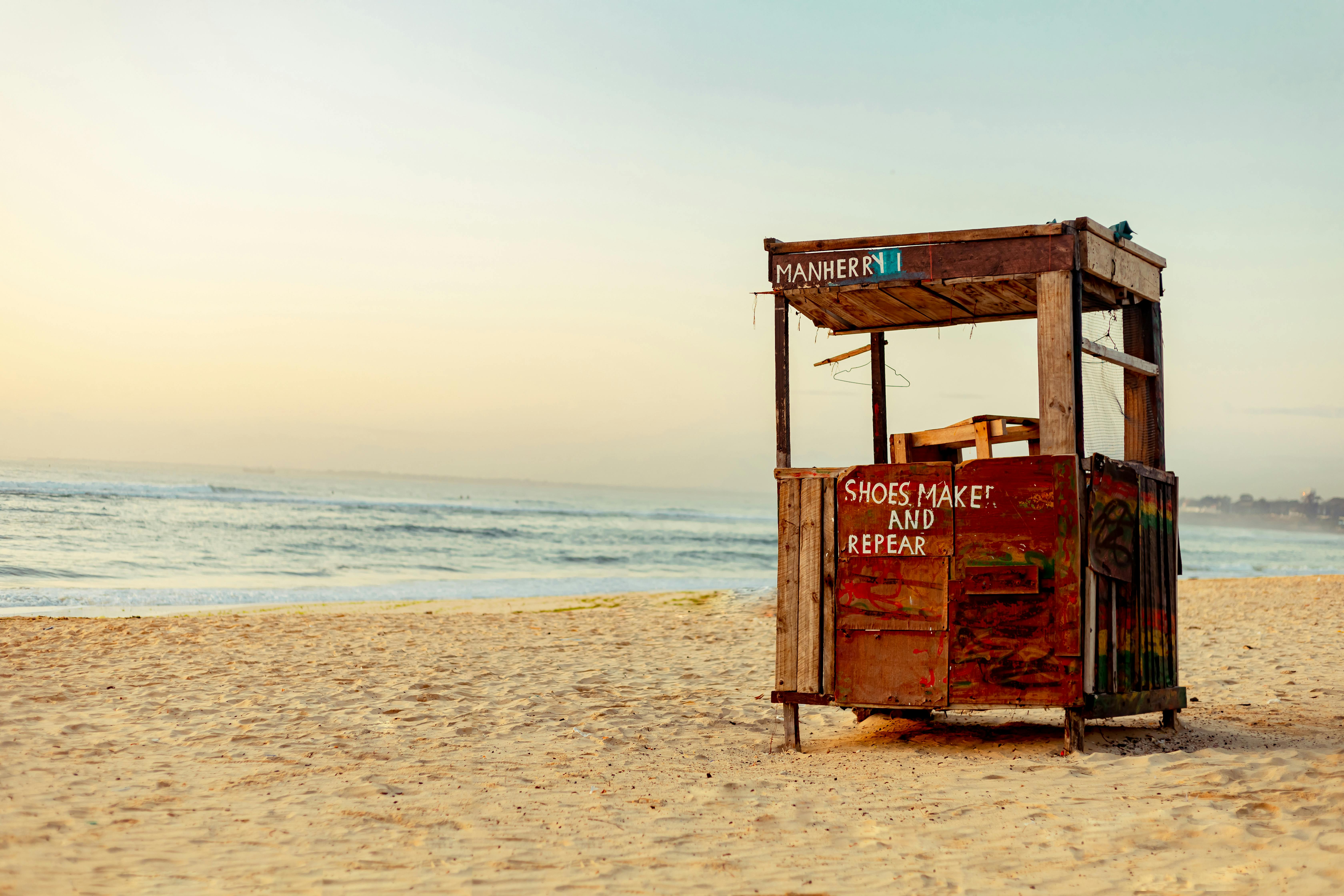 Brown Wooden Lifeguard House on Beach Shore · Free Stock Photo