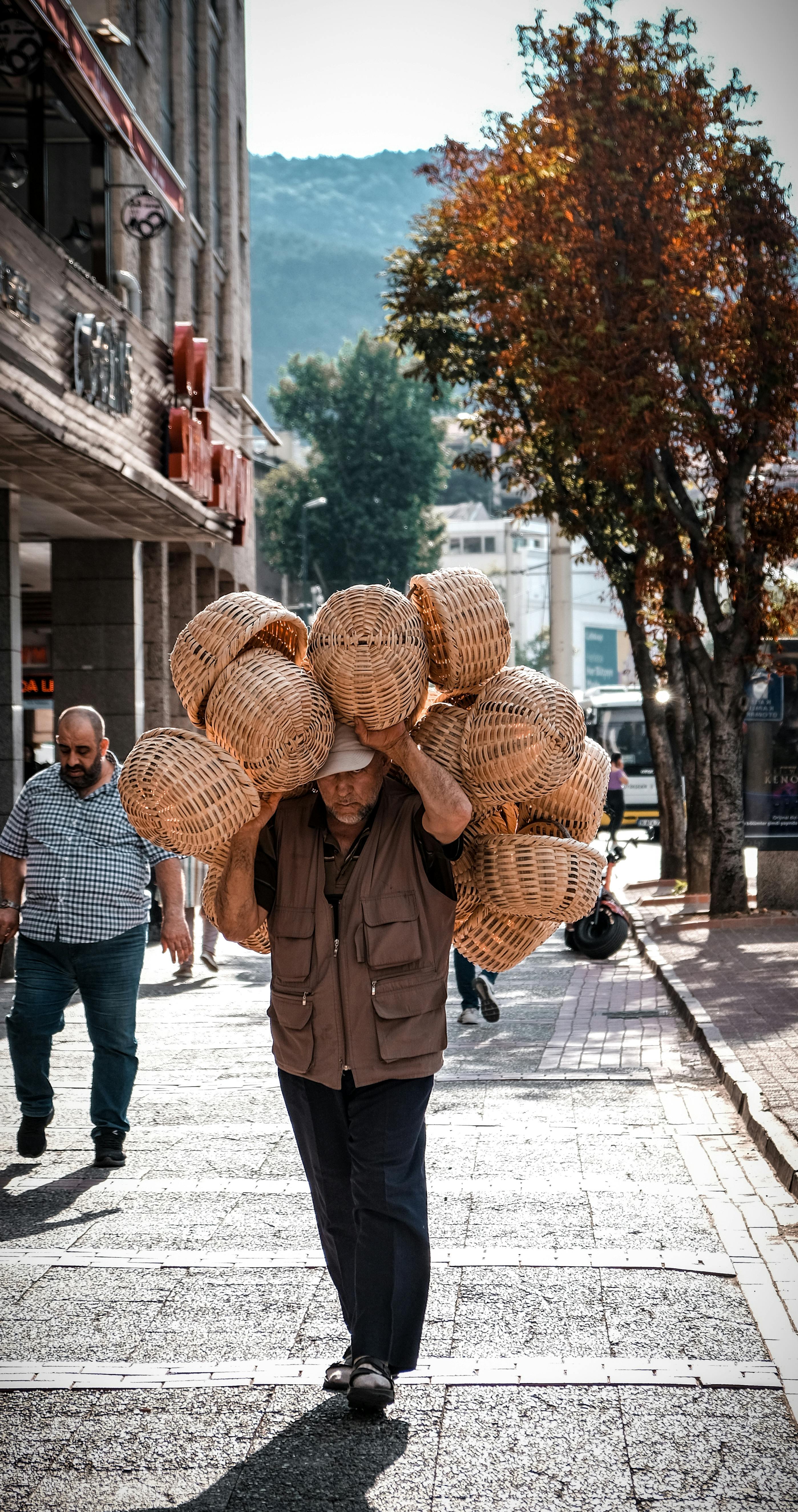 Man Carrying Woven Baskets · Free Stock Photo