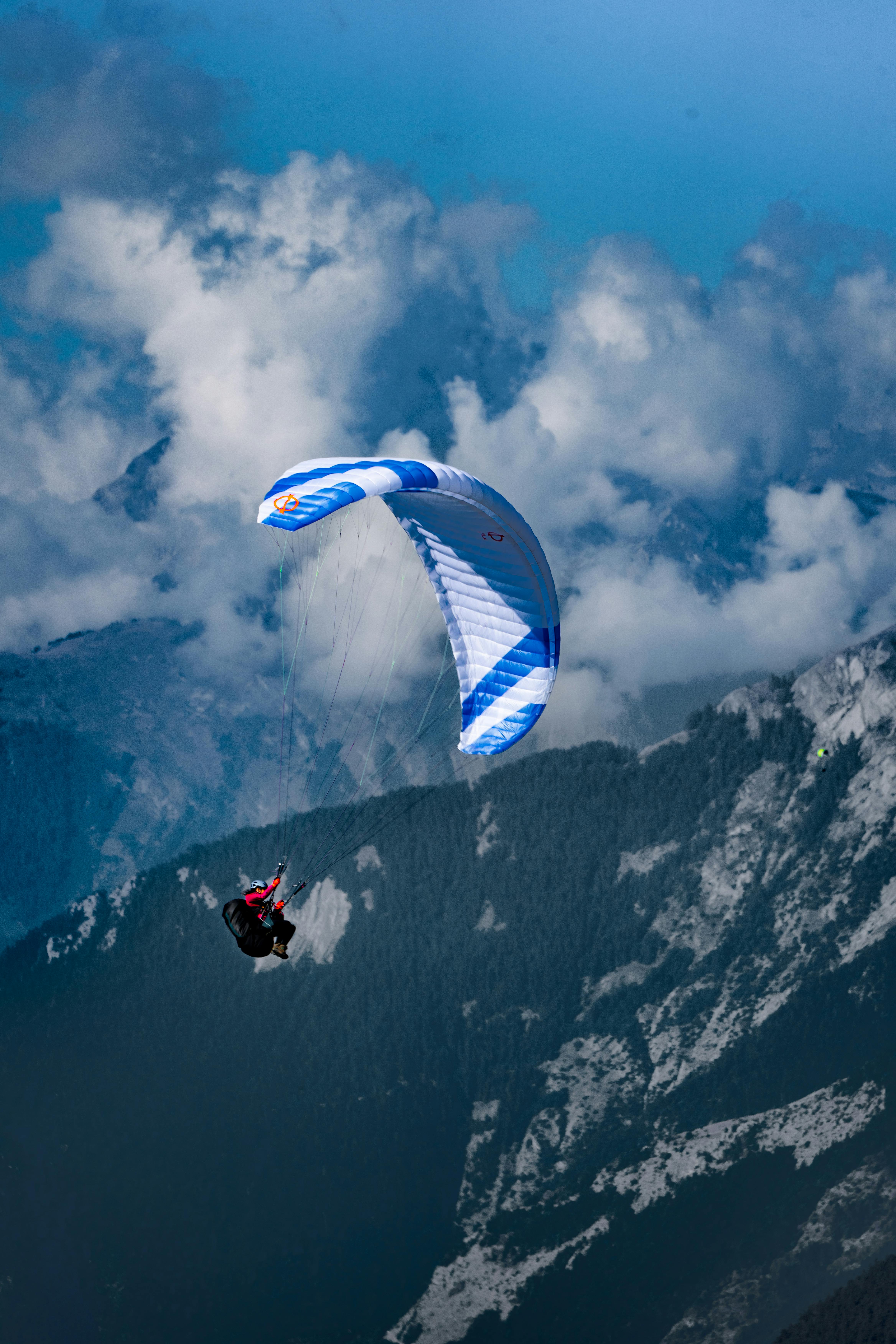 A Person Paragliding by the Mountains · Free Stock Photo